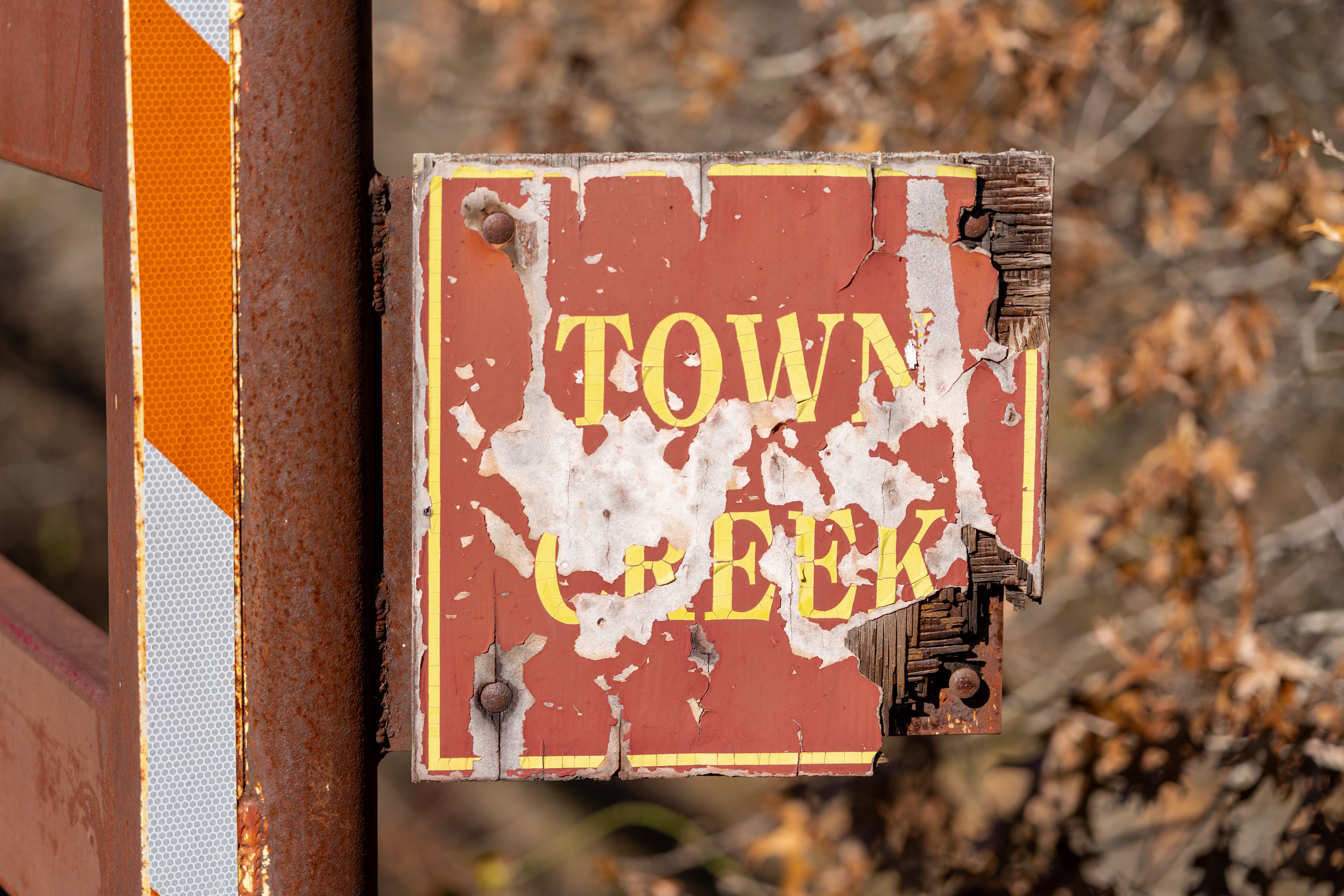Rustic Town Creek Sign in Autumn Setting · Free Stock Photo