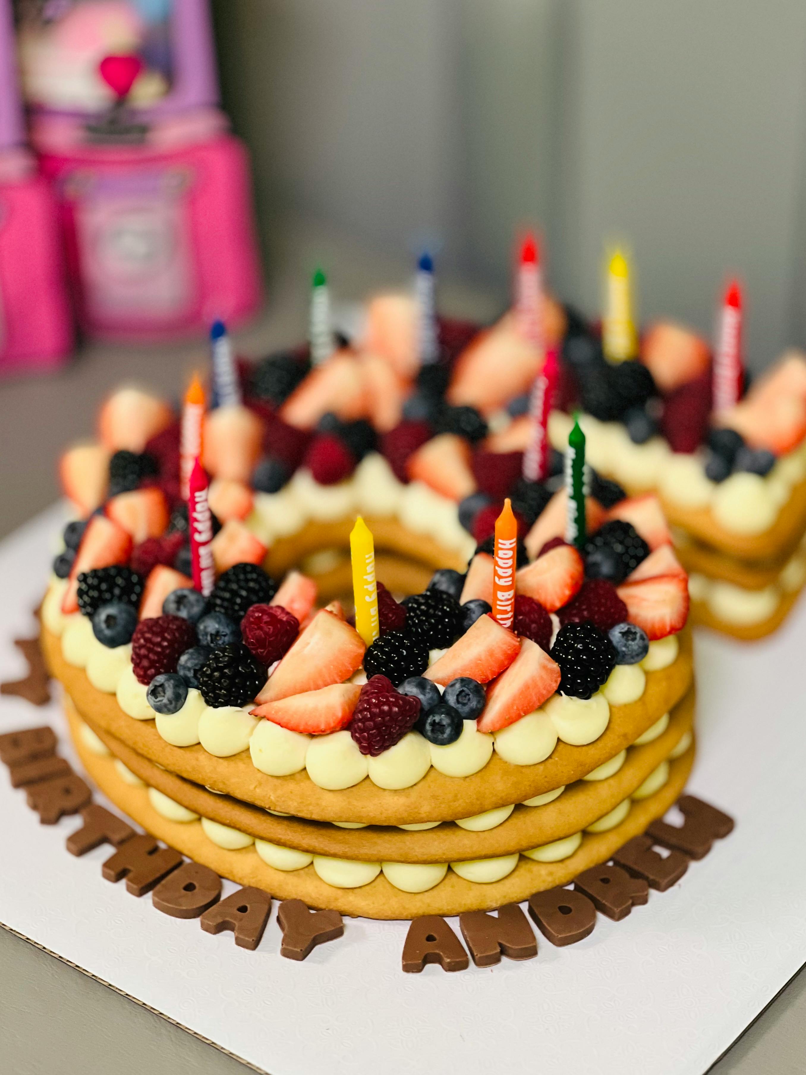 Vibrant Birthday Cake with Fresh Berries and Candles · Free Stock Photo