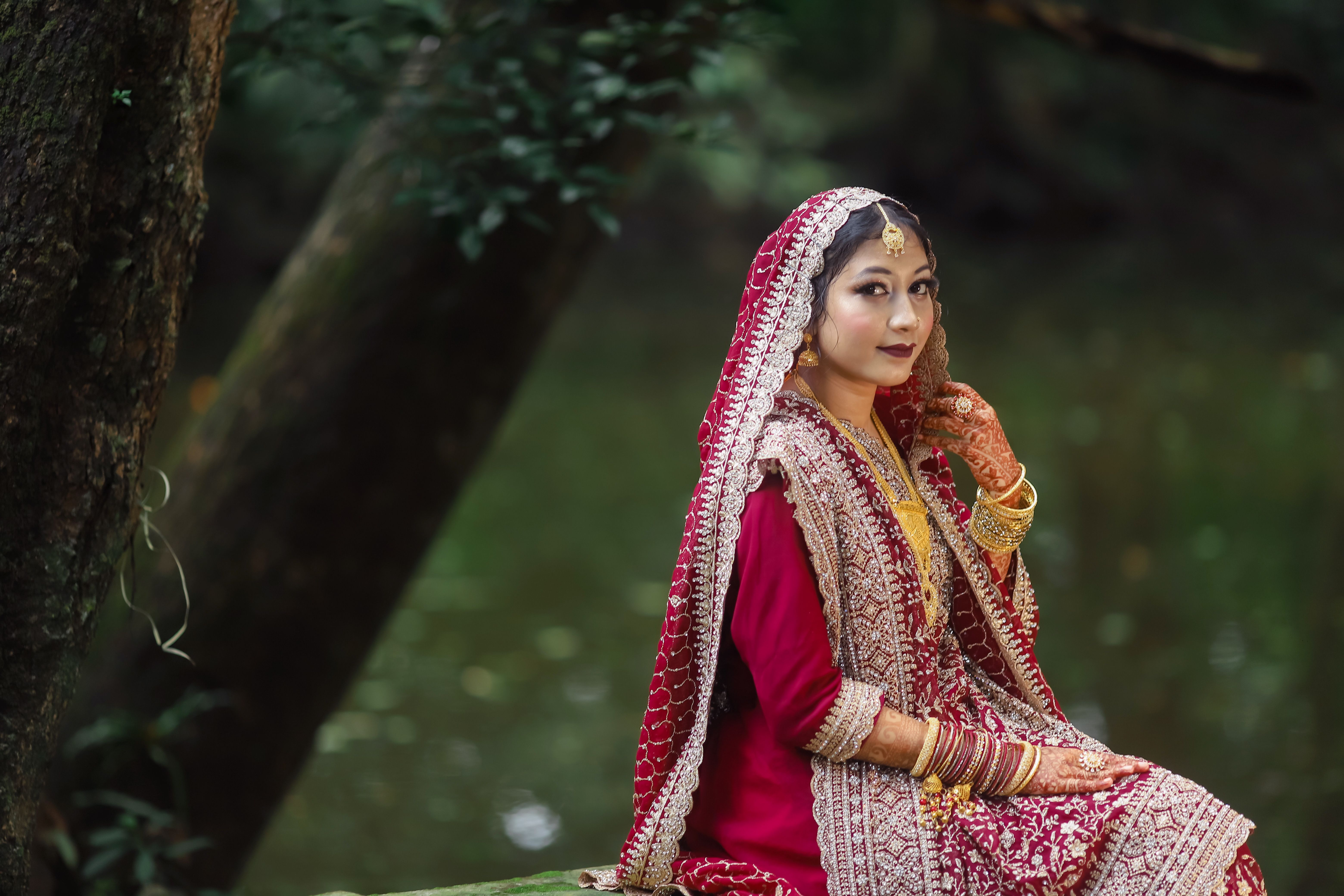 Elegant Traditional Bride in Scenic Outdoor Setting · Free Stock Photo
