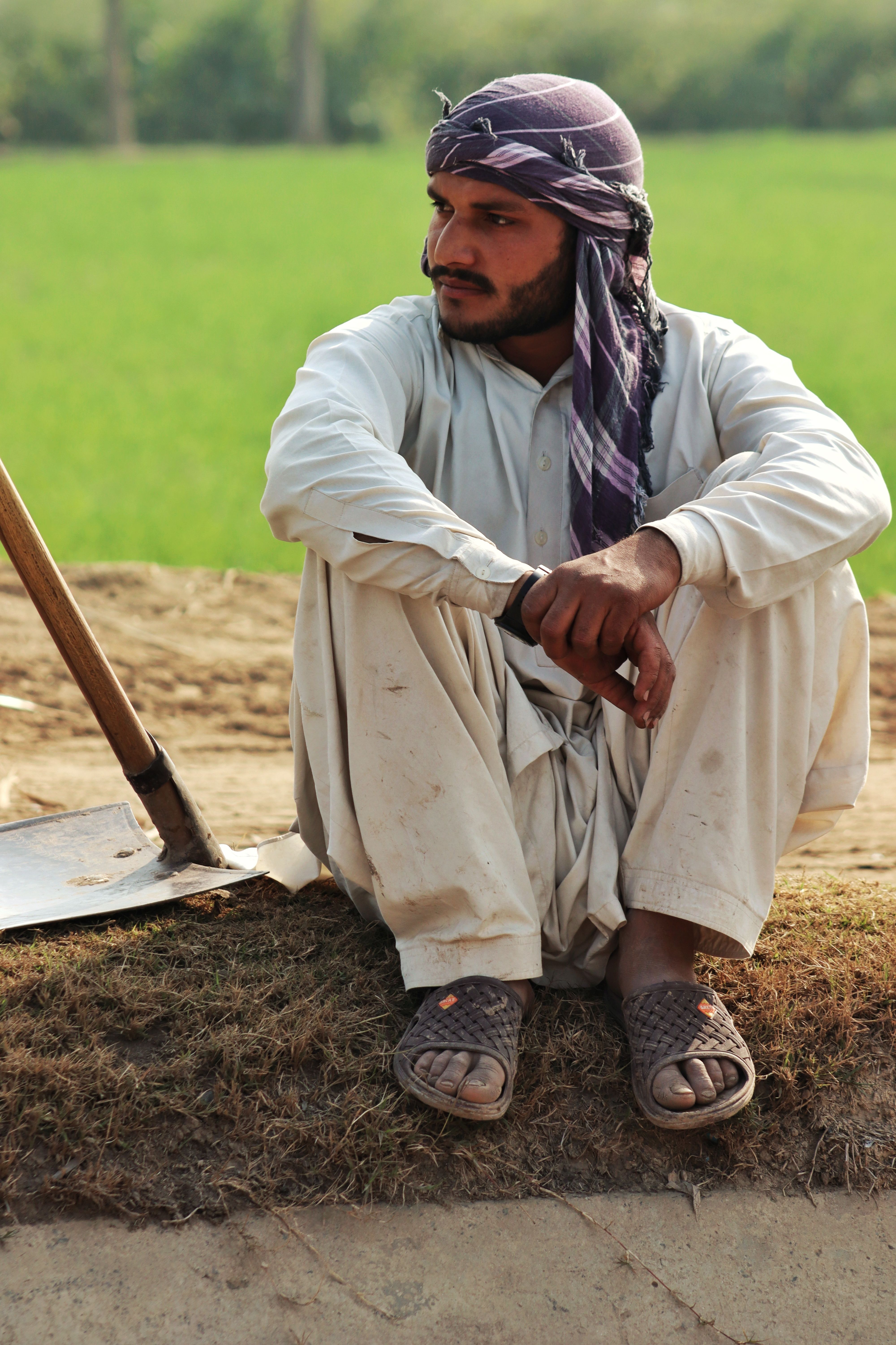 South Asian Farmer Resting in the Field · Free Stock Photo
