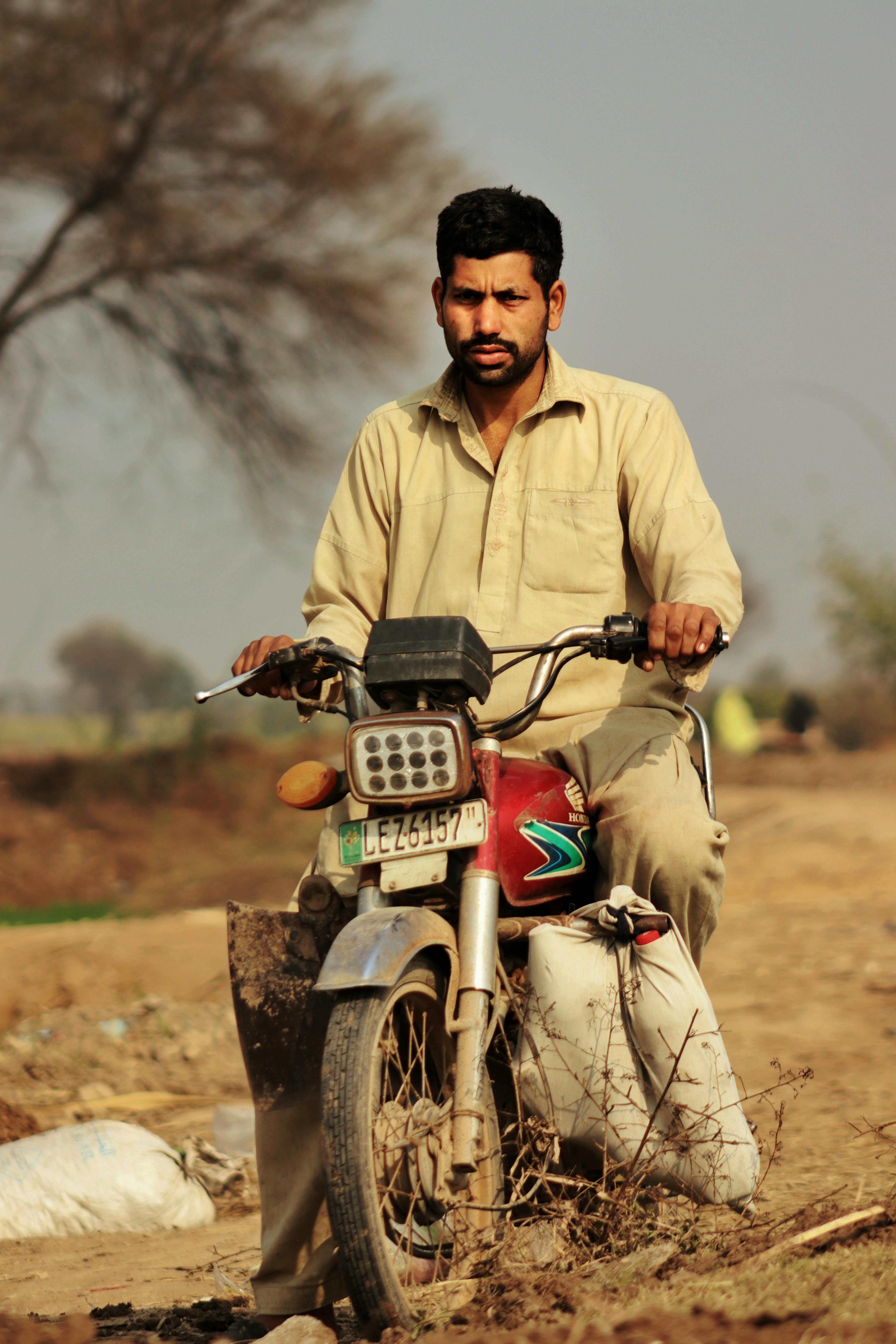 Rural Farmer Riding Motorcycle in Punjab, Pakistan · Free Stock Photo