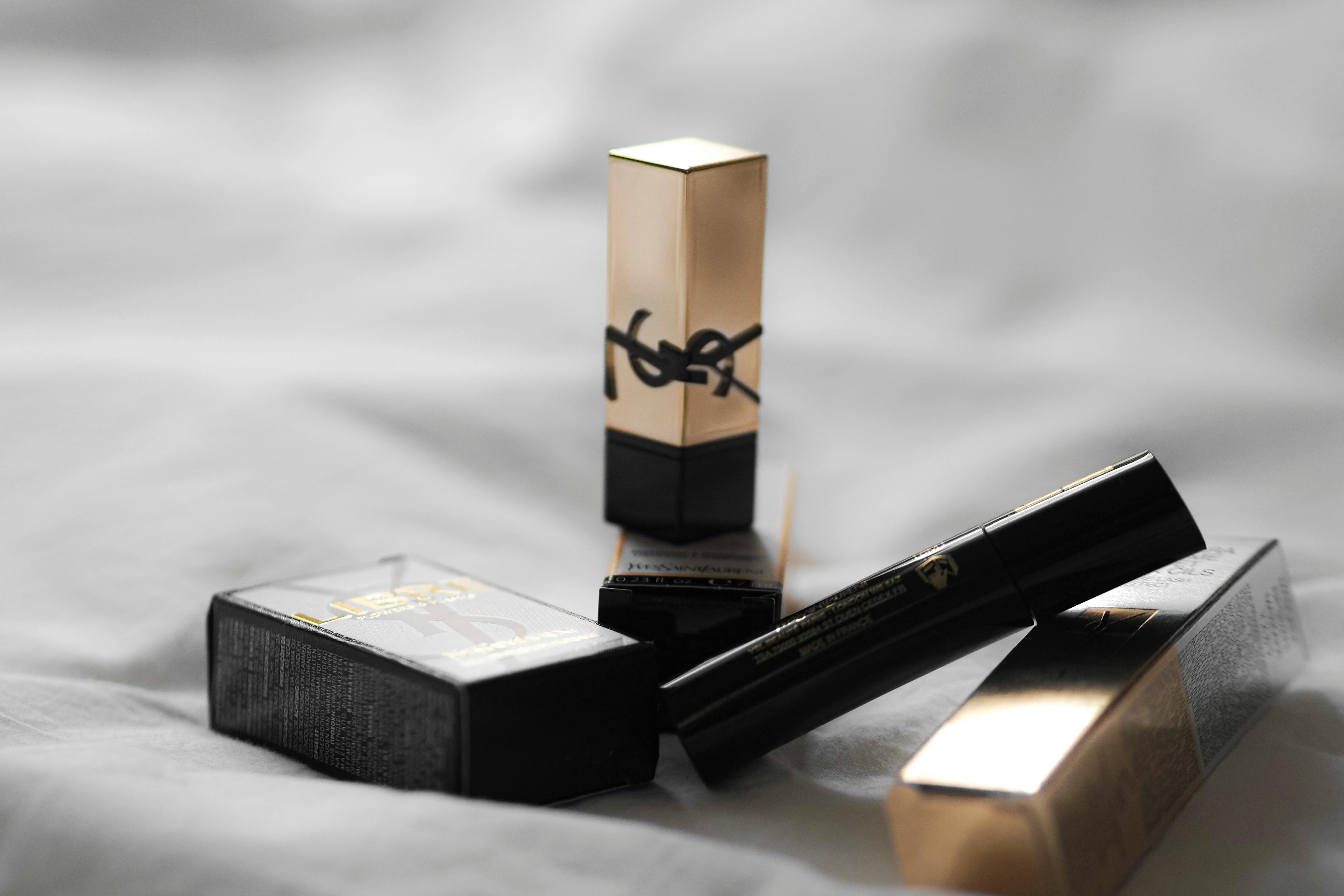 Luxurious YSL Makeup Display on Soft Fabric · Free Stock Photo