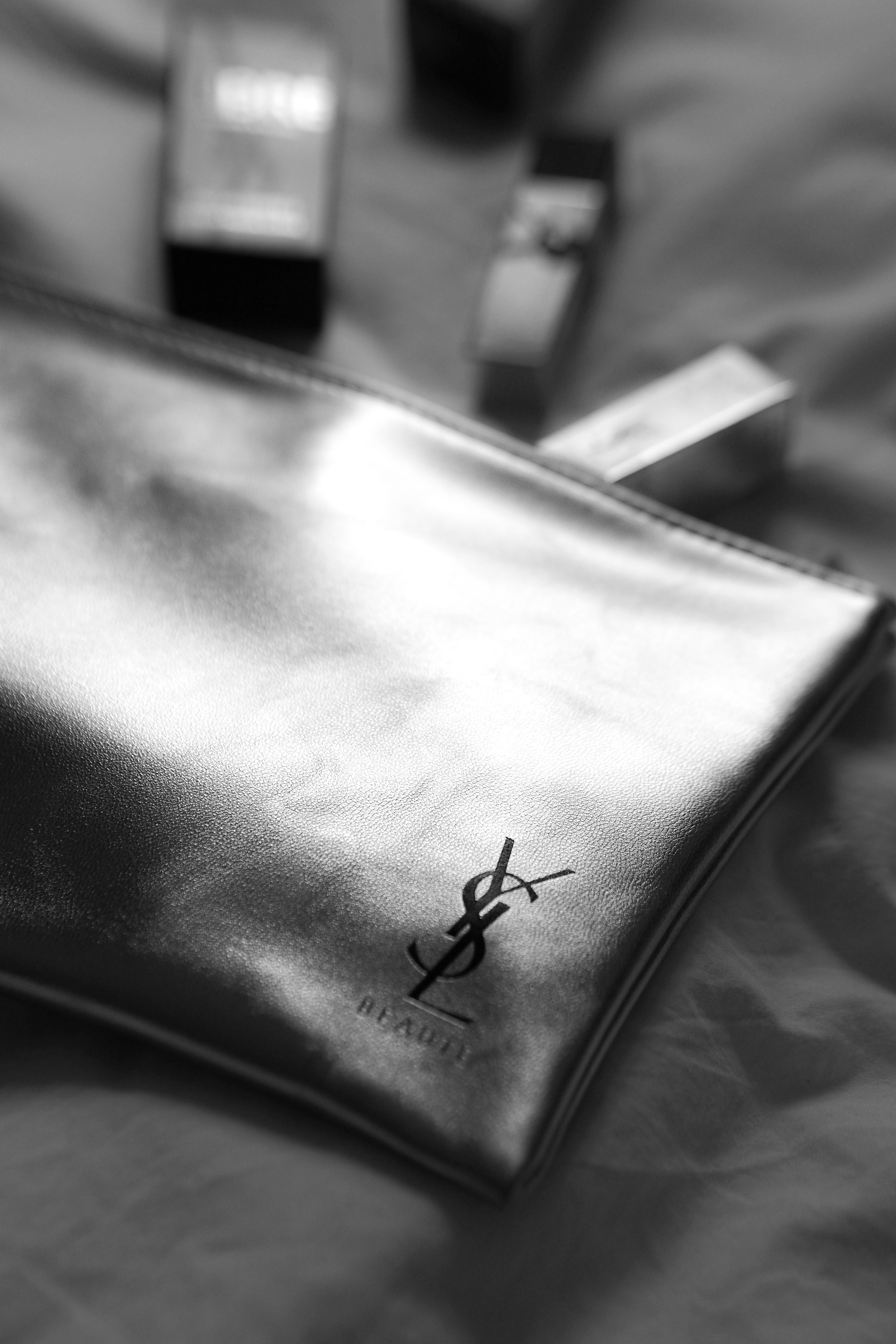 Luxury YSL Silver Cosmetic Bag on Display · Free Stock Photo
