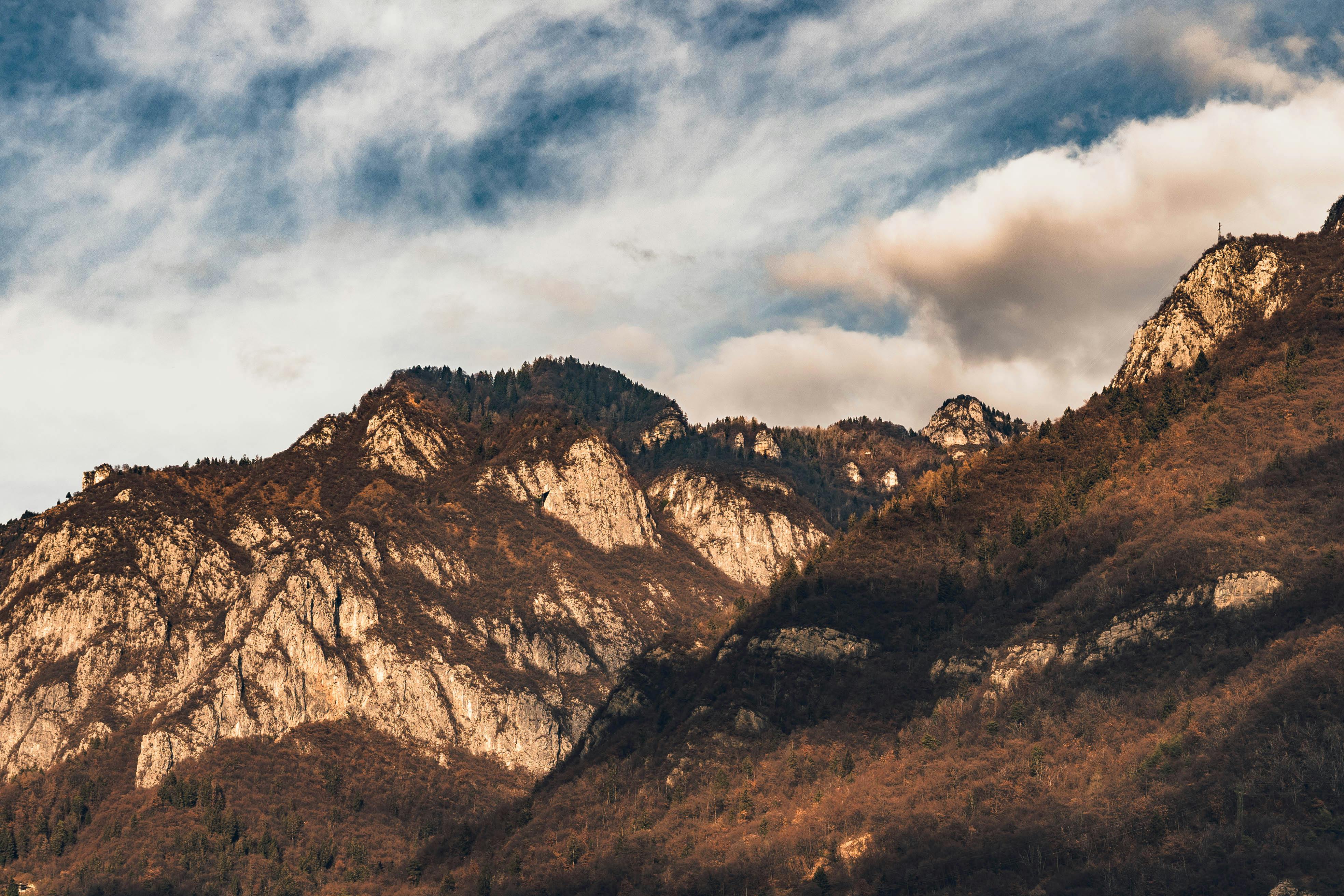 Scenic Mountain Range Under Cloudy Sky · Free Stock Photo