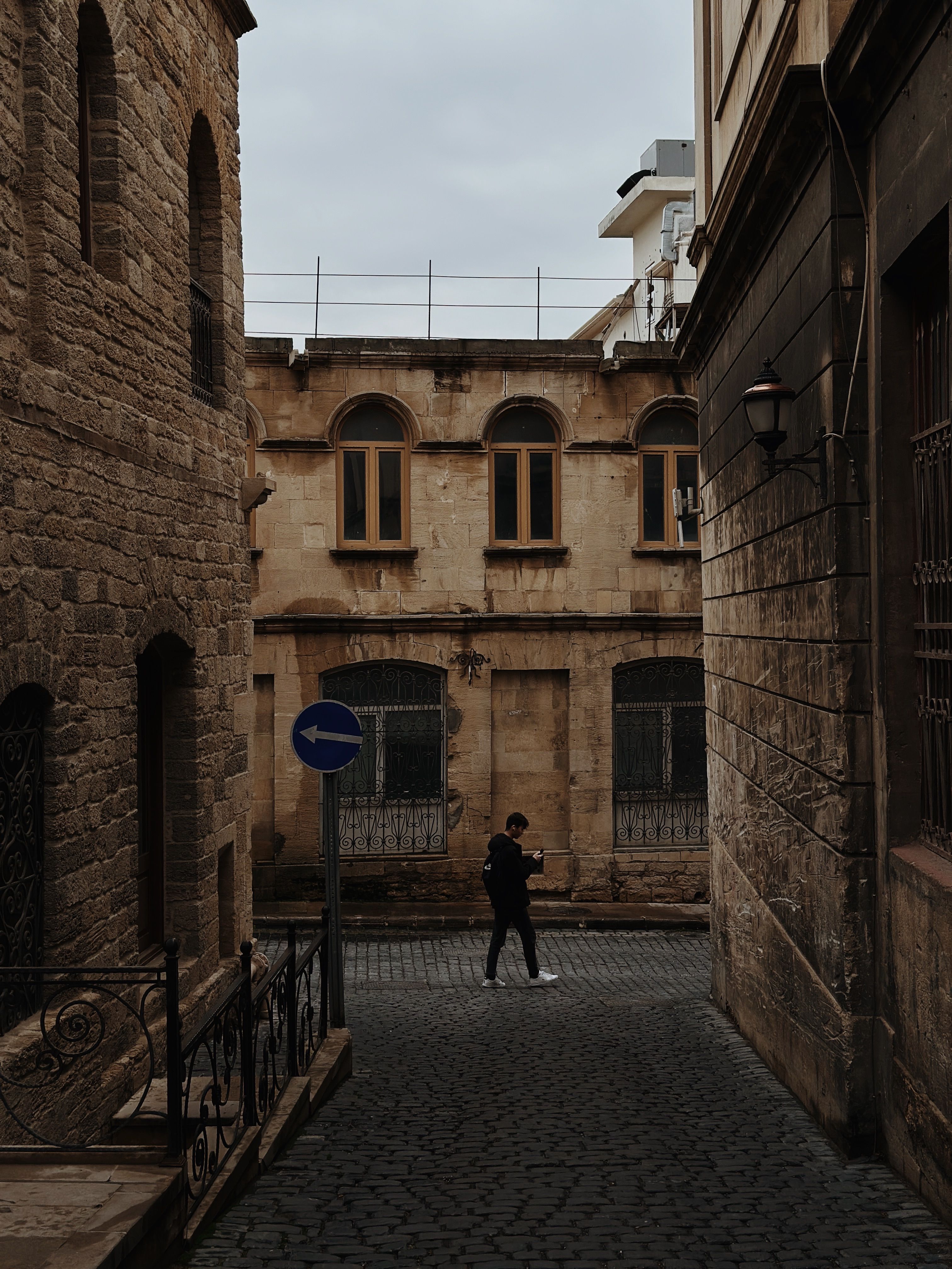 Person Walking in Narrow Historic Alleyway · Free Stock Photo