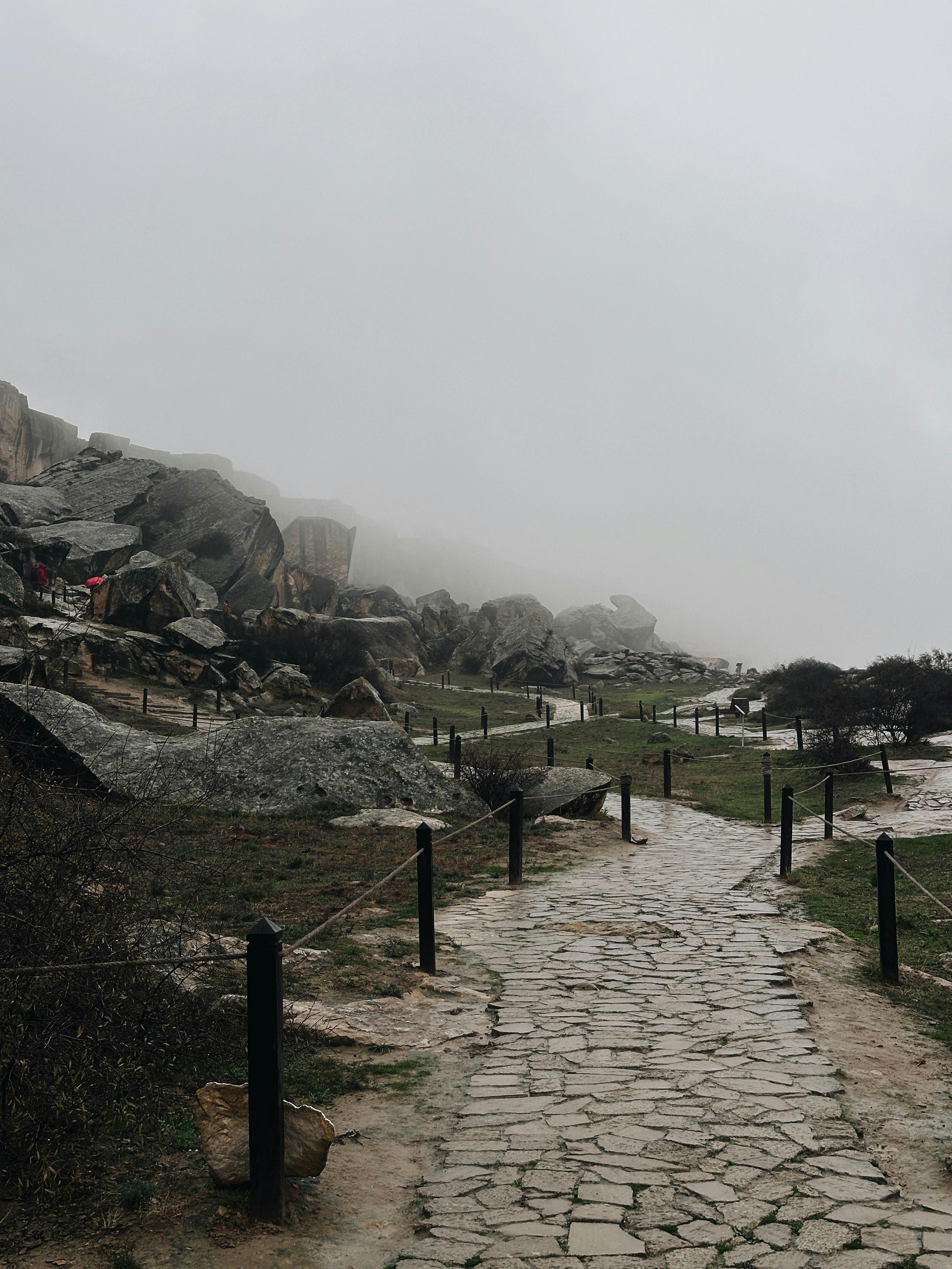 Foggy Mountain Pathway with Rocky Terrain · Free Stock Photo