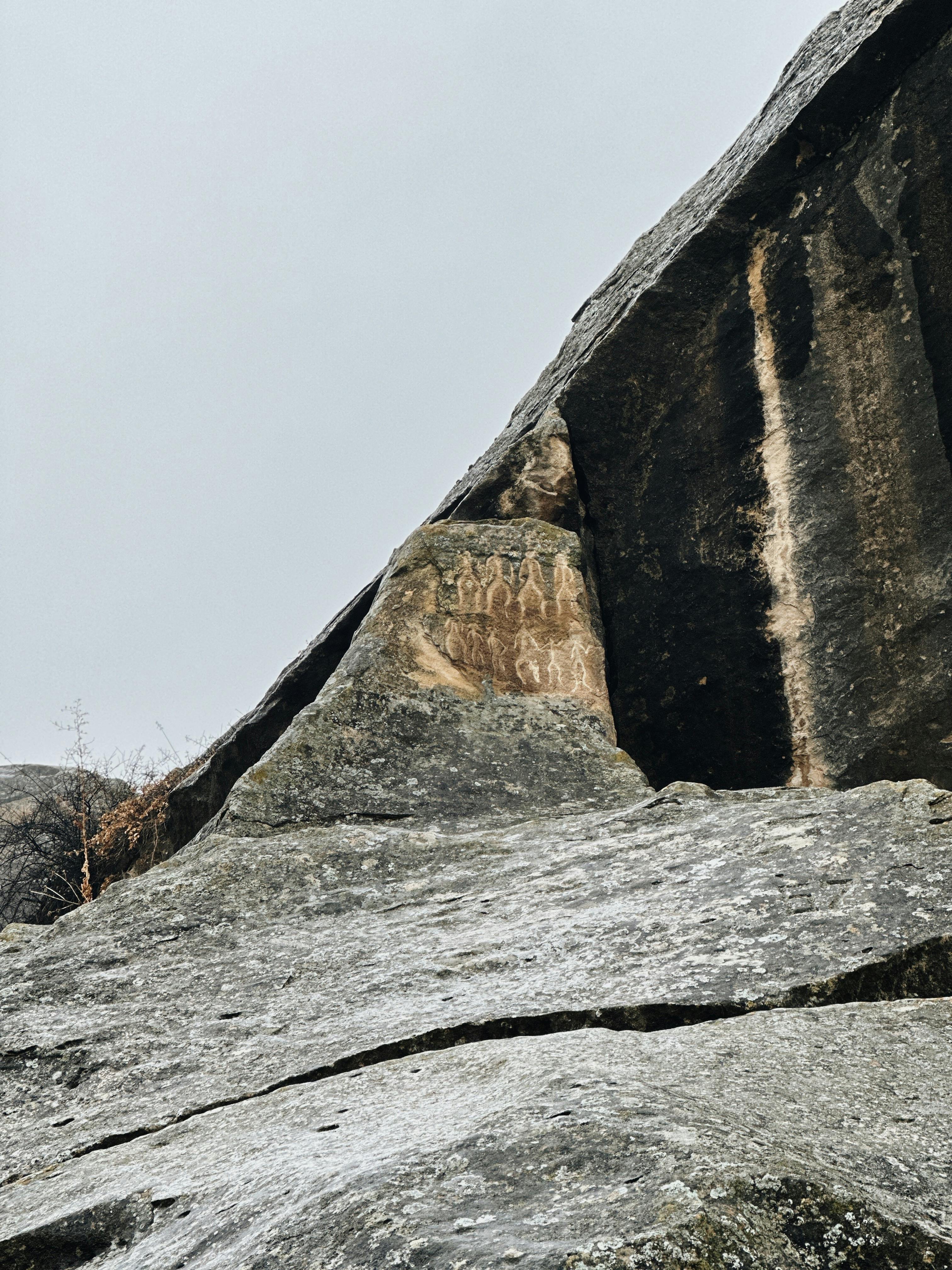 Ancient Rock Carvings on Weathered Cliff Face · Free Stock Photo