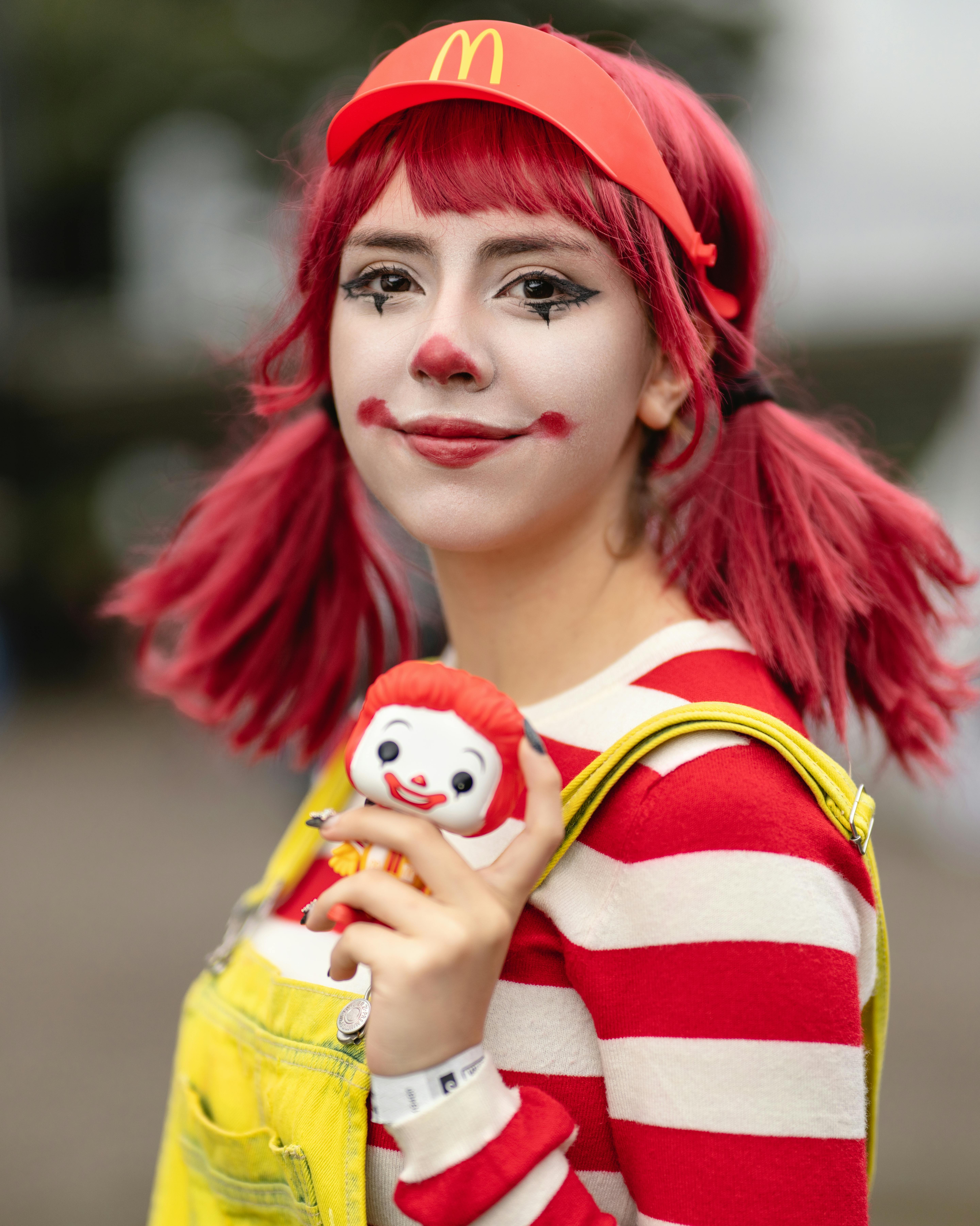 Colorful Cosplay Character Holding Toy · Free Stock Photo