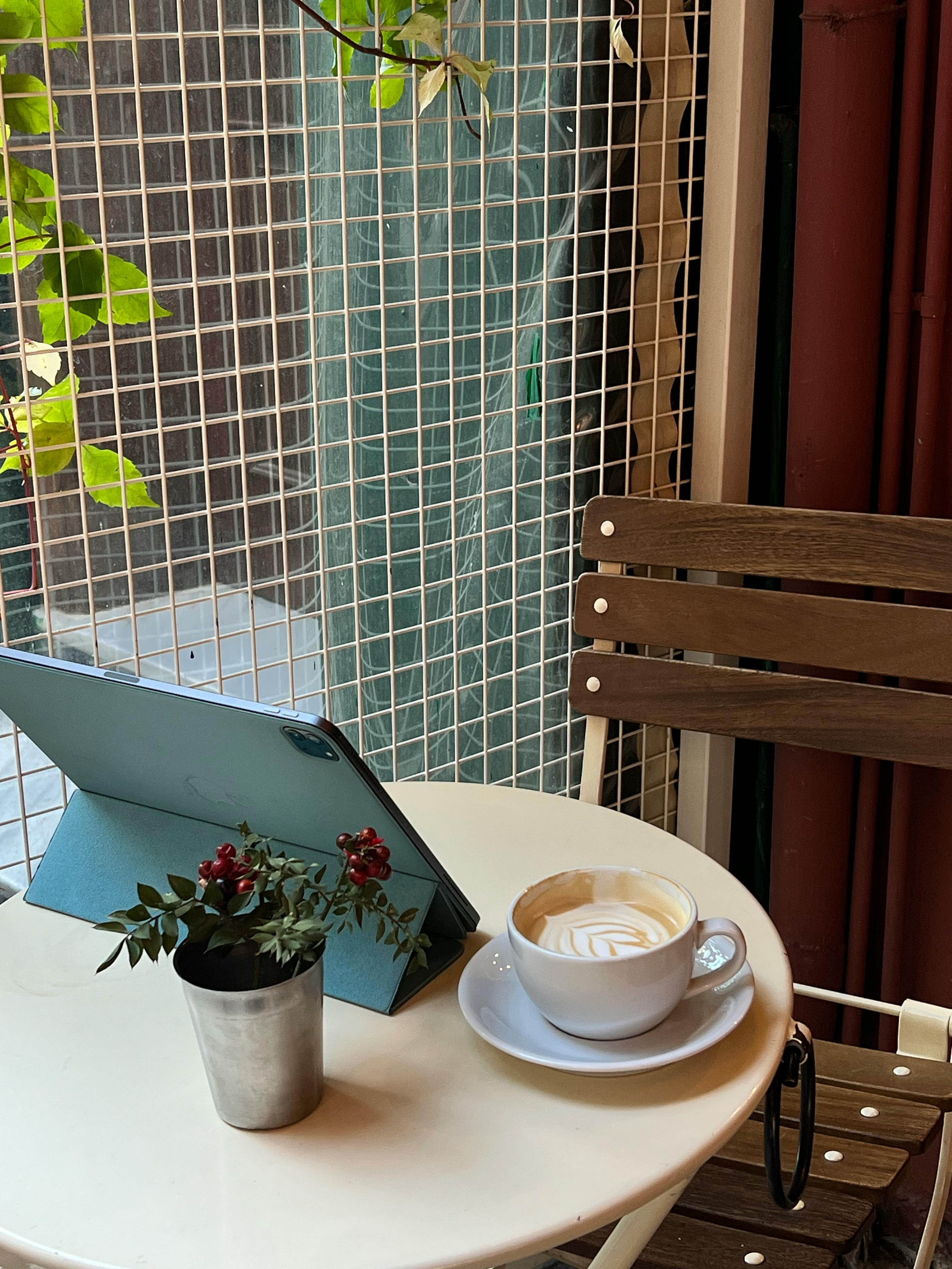 Cozy Outdoor Cafe Setup with Coffee and Tablet · Free Stock Photo