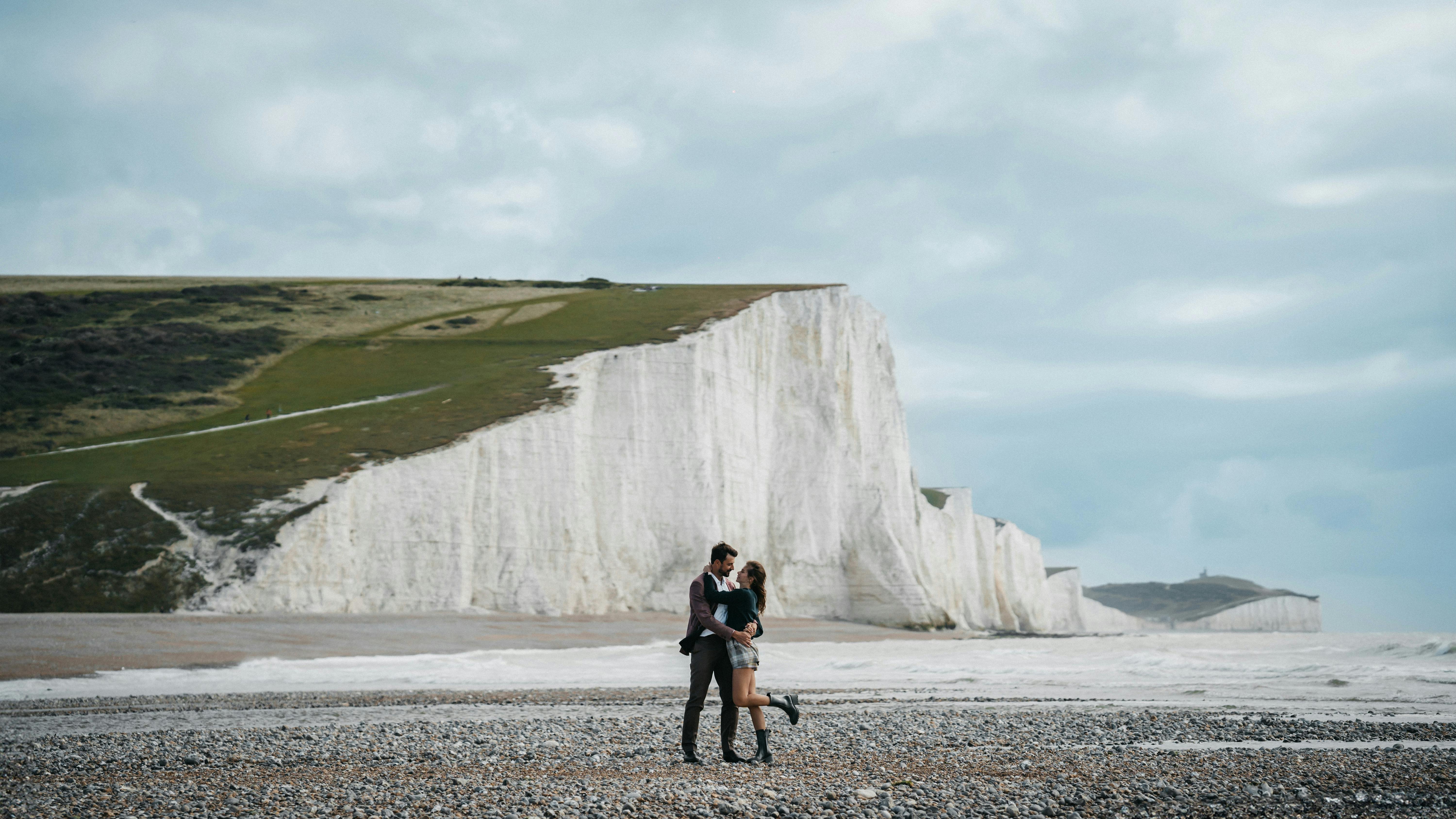 Couple Embracing Near Seven Sisters Cliffs · Free Stock Photo
