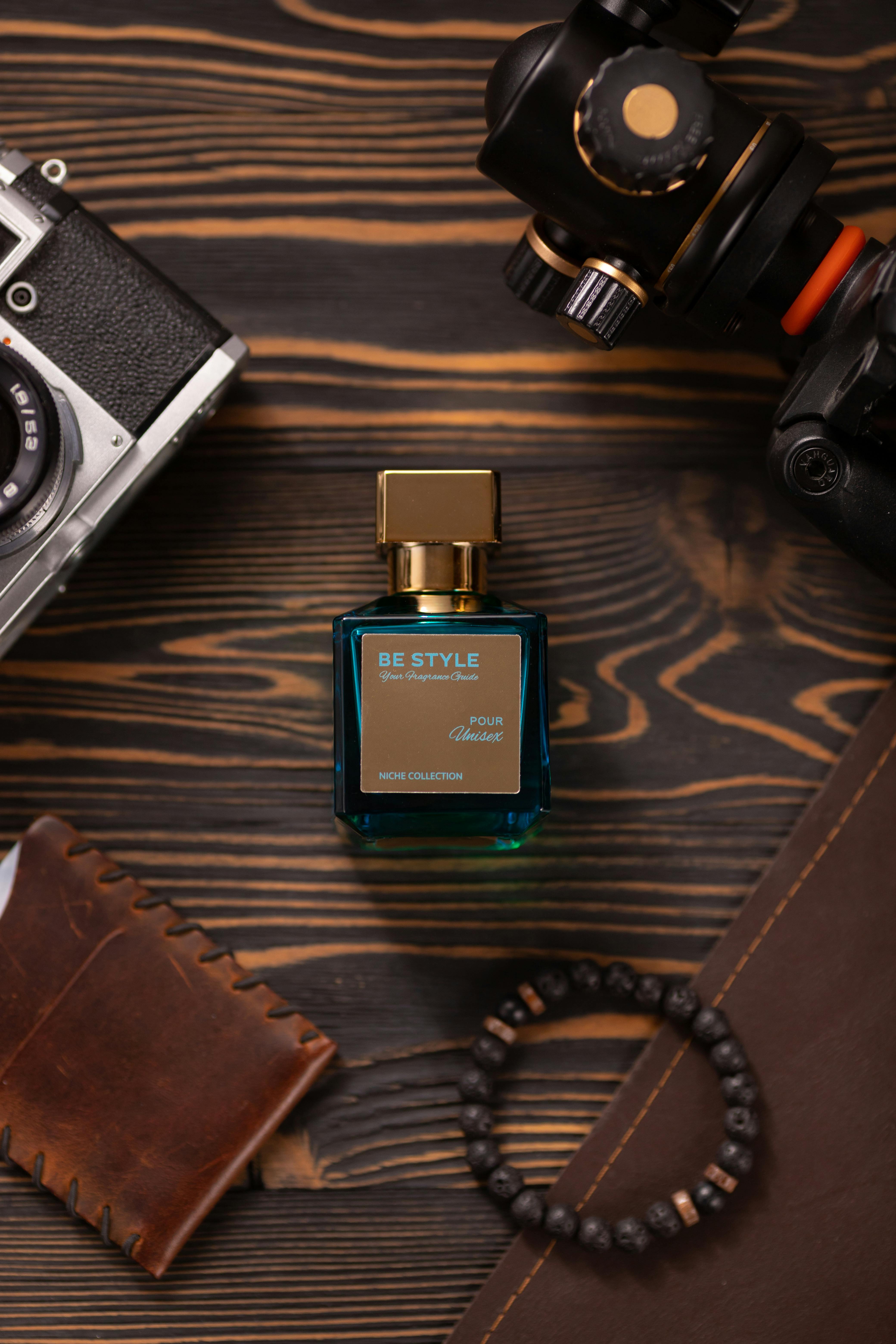 Stylish Perfume Bottle on Textured Wooden Table · Free Stock Photo