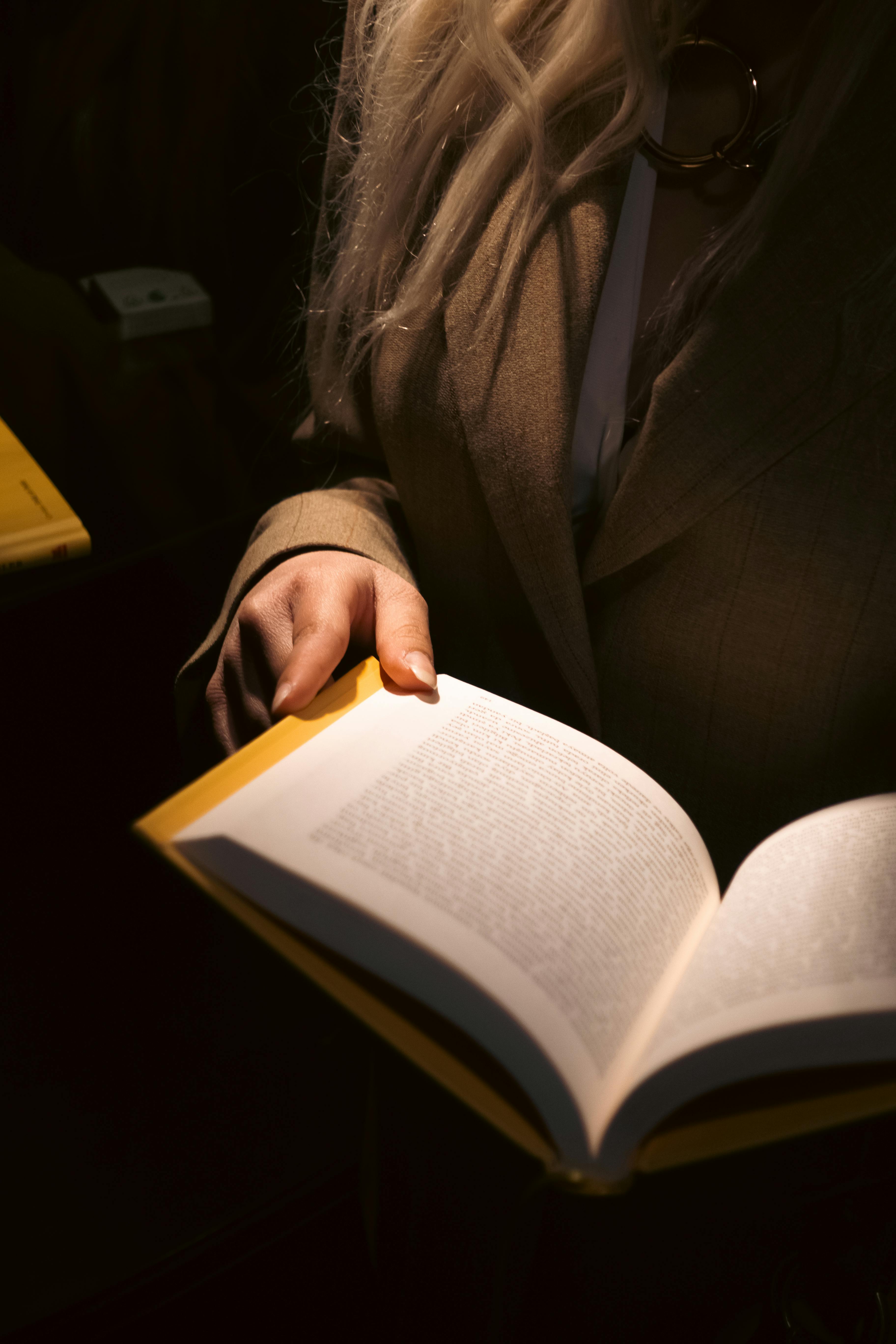 Elegant Woman Reading in Dim Light · Free Stock Photo