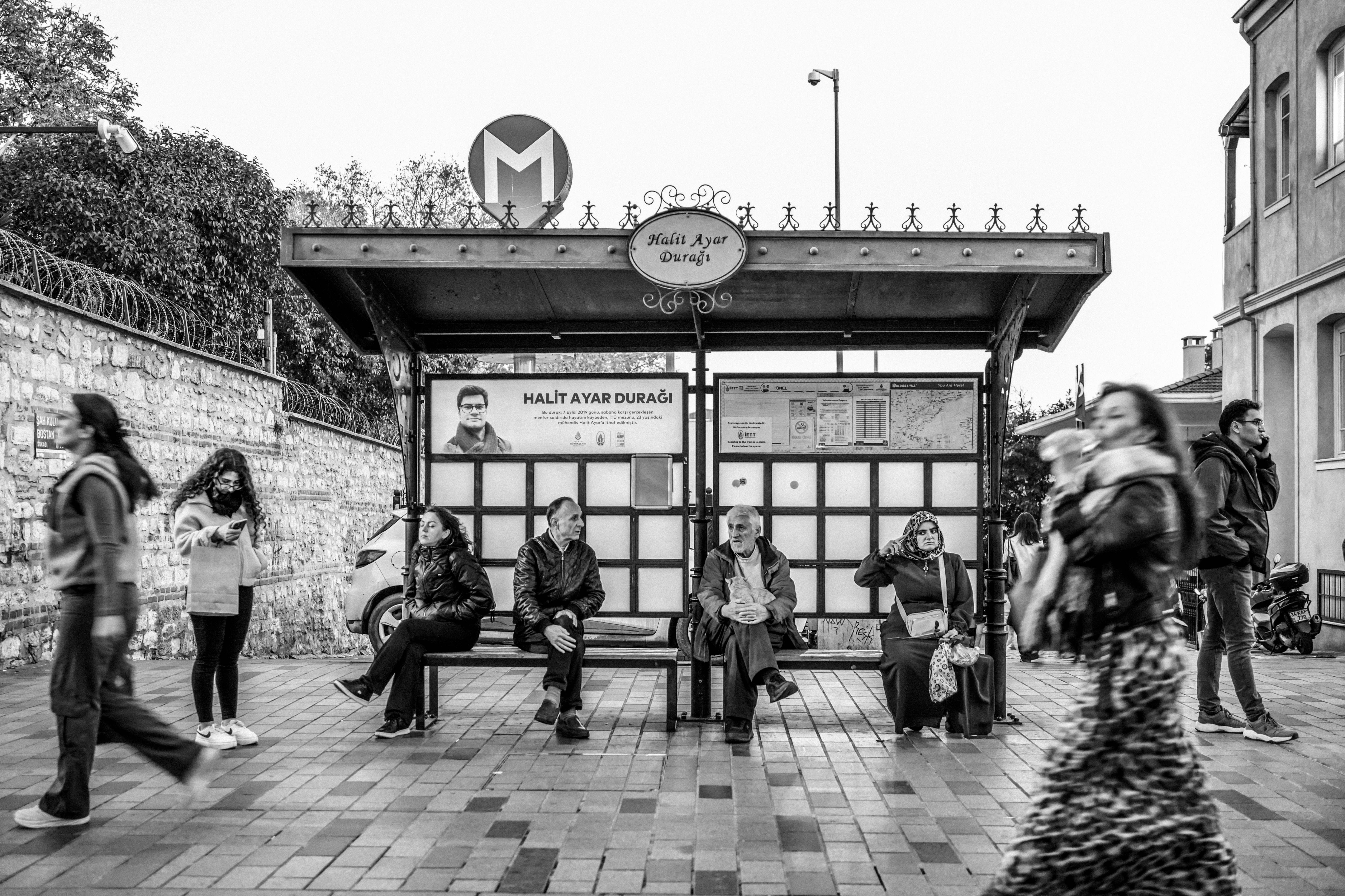 Black and White City Bus Stop Scene with Commuters · Free Stock Photo