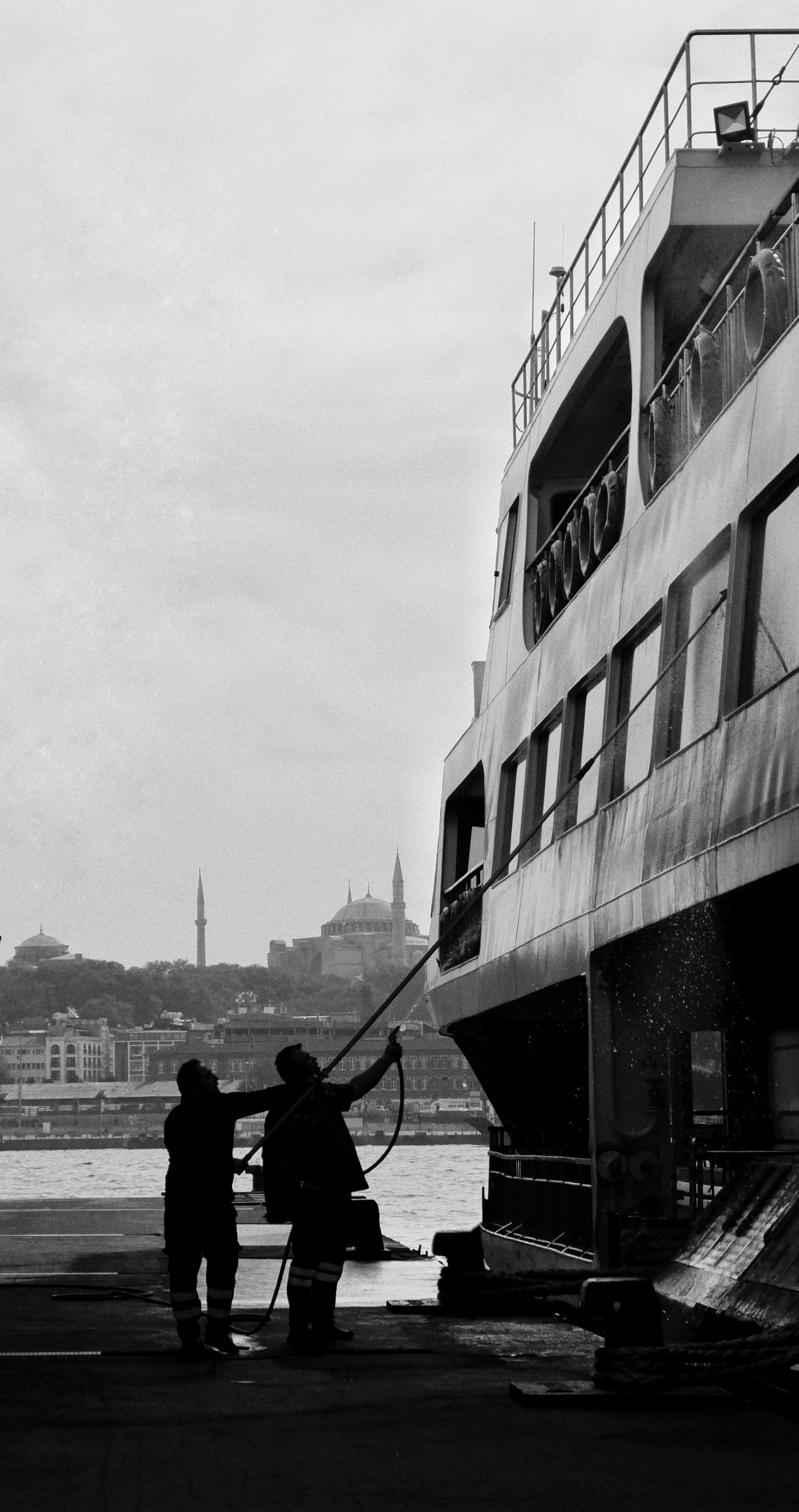 Silhouette of Workers Cleaning a Ferry in Istanbul Harbor · Free Stock ...