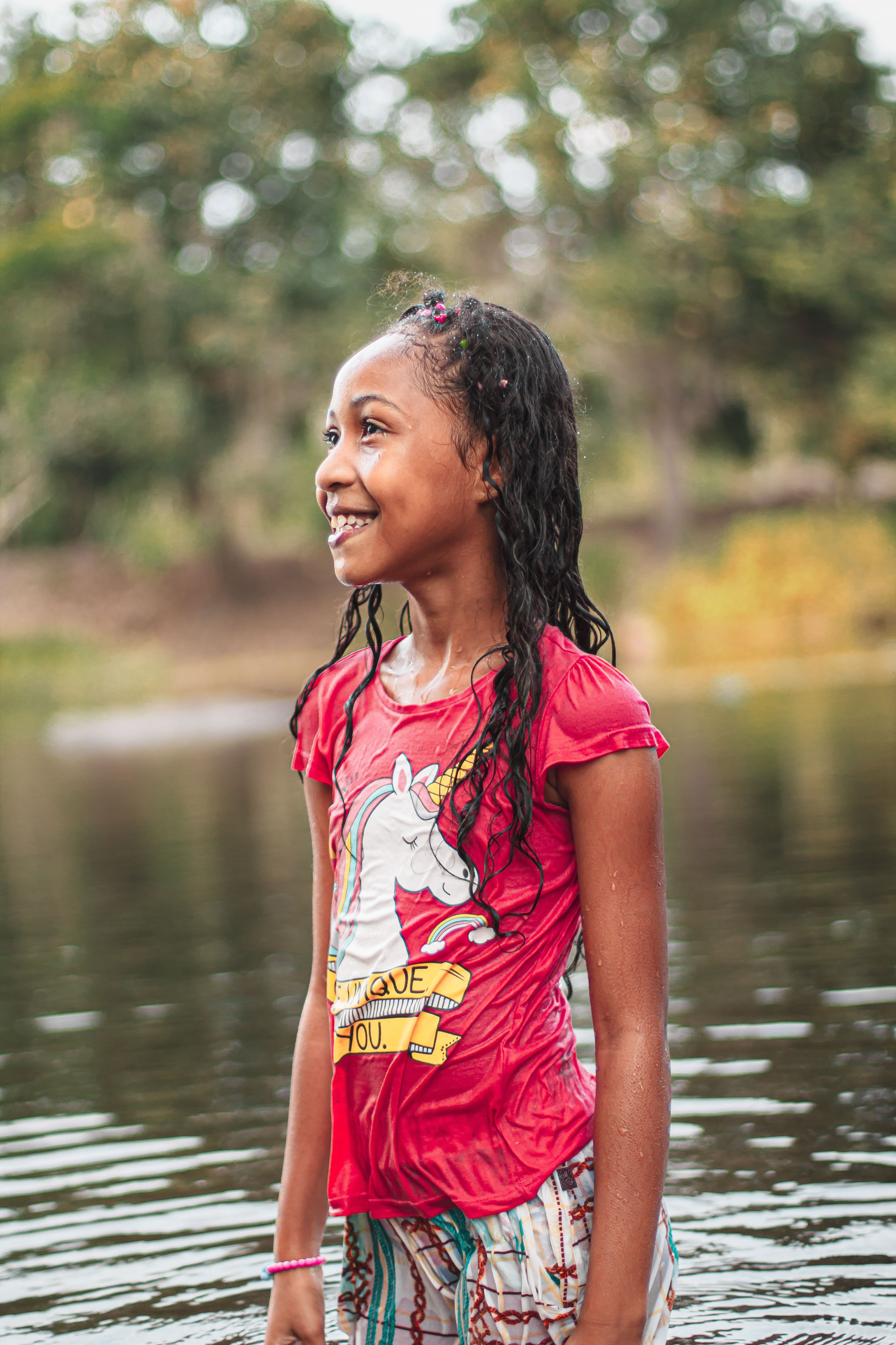 Joyful girl standing in a river embracing nature · Free Stock Photo