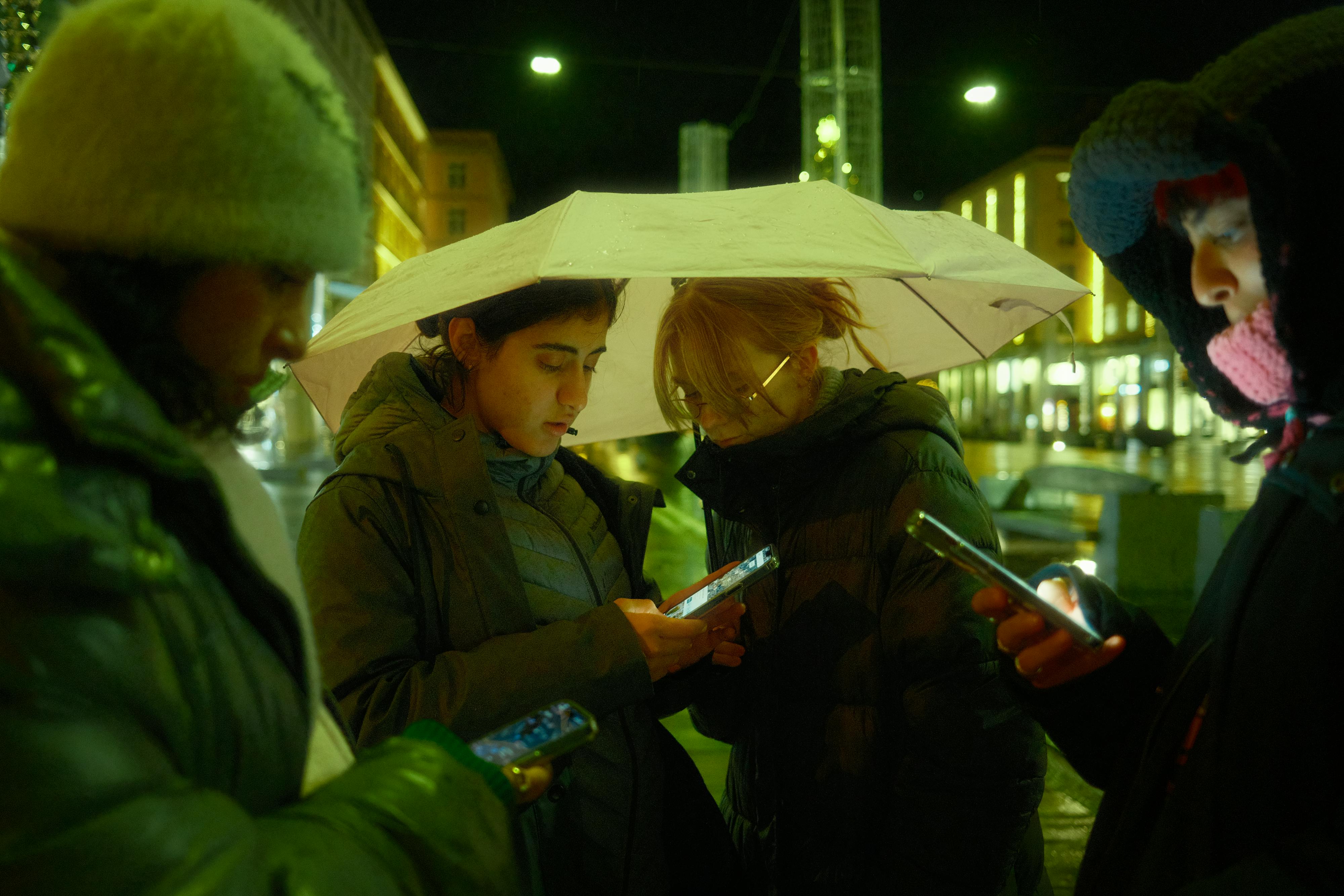 Night Street Scene with Friends Under Umbrella · Free Stock Photo