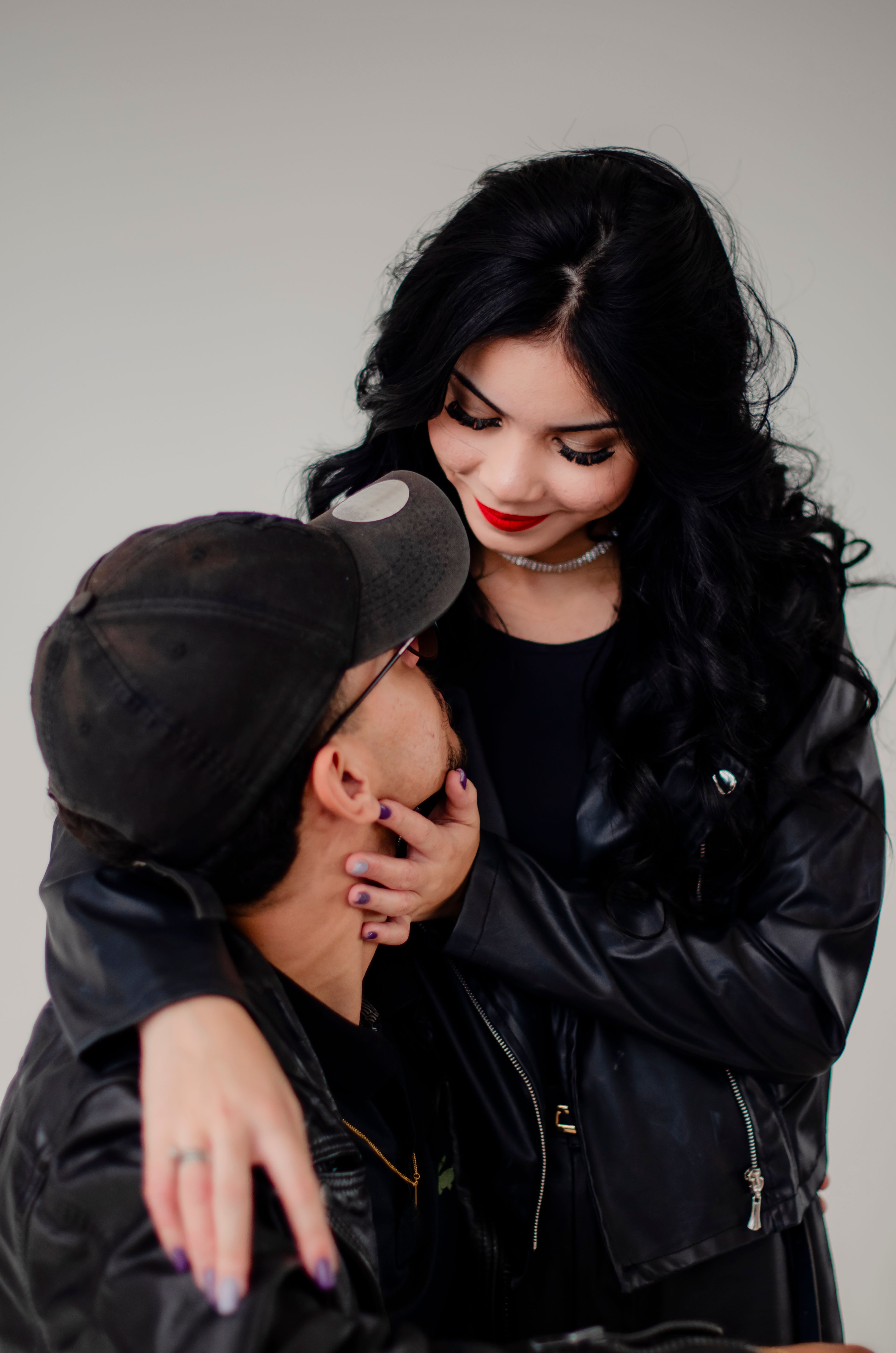 Romantic Couple in Black Leather Jackets Embrace · Free Stock Photo