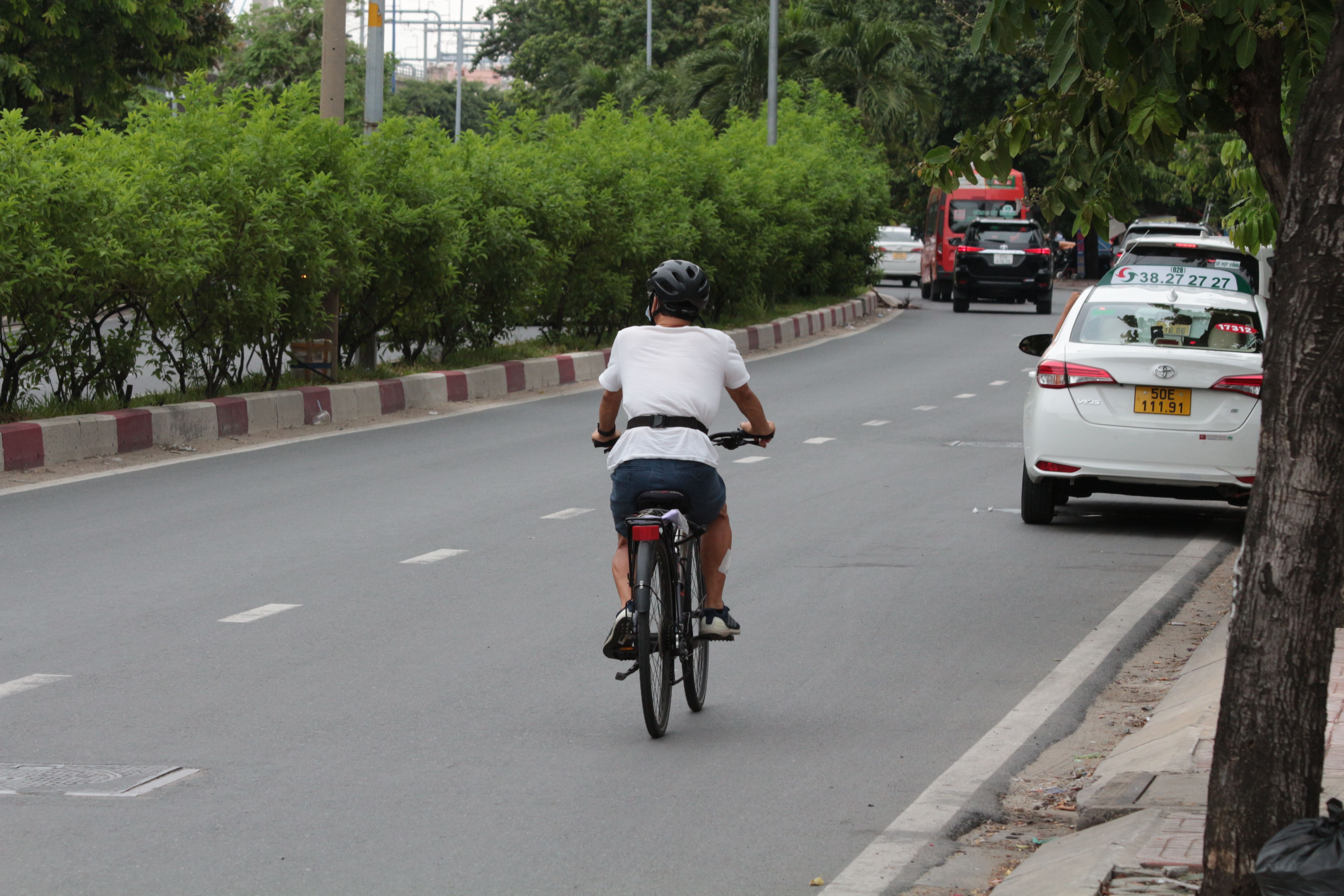 Cyclist Riding on Urban Street in Daylight · Free Stock Photo