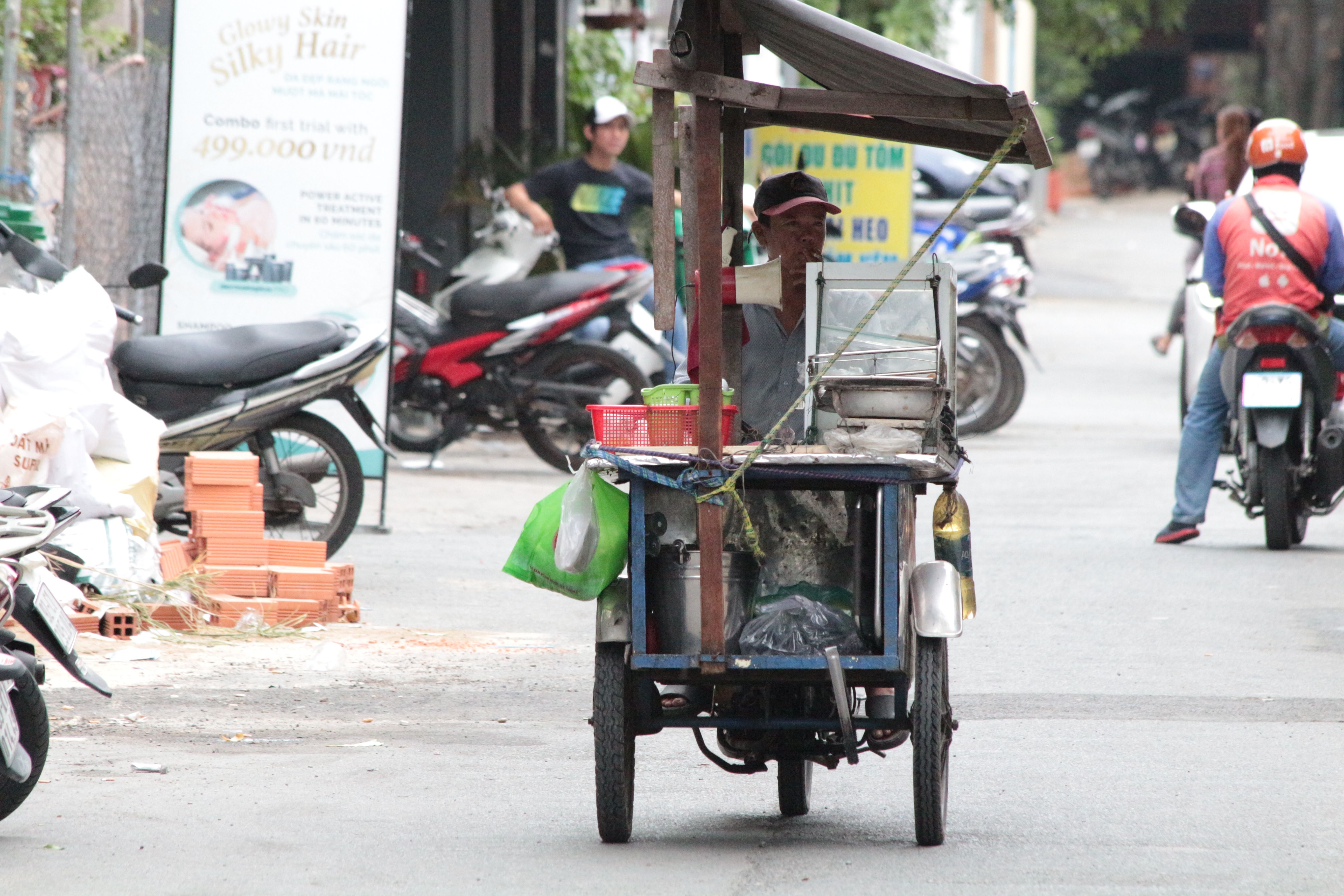 Street Food Vendor Operating in Busy Urban Area · Free Stock Photo