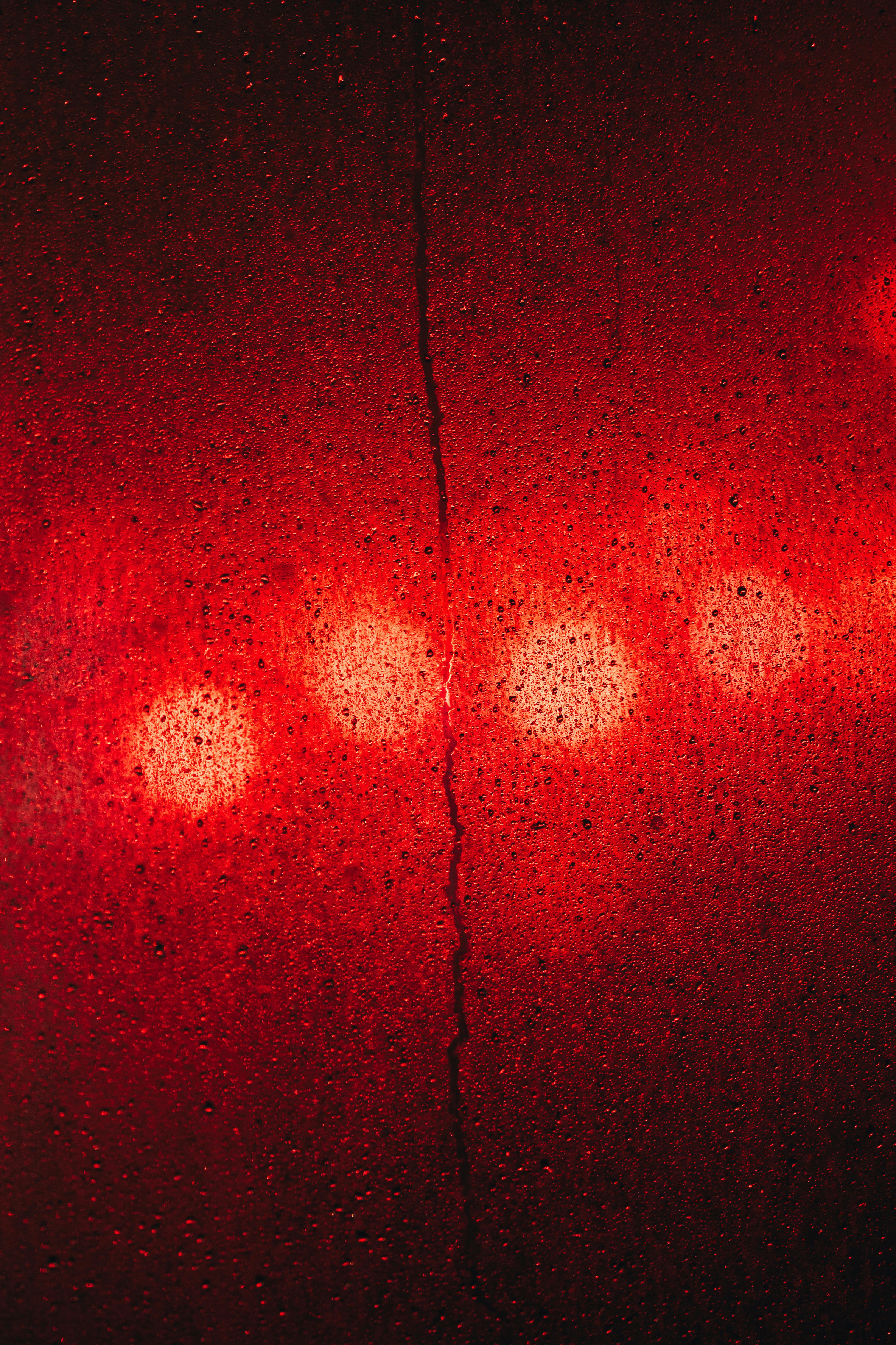 Abstract Red Light Reflections on a Wet Surface · Free Stock Photo