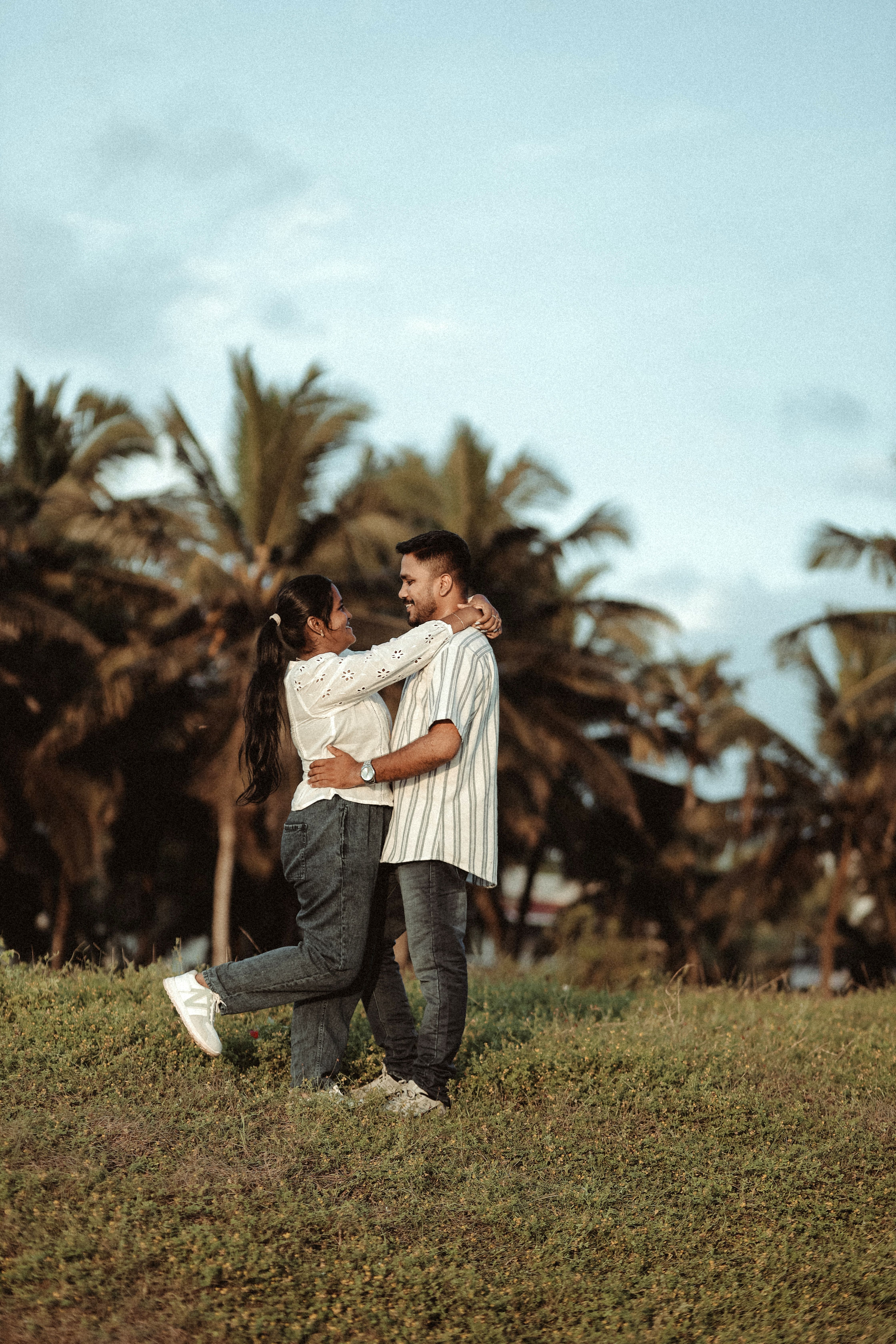 Romantic Couple Embracing in Lush Landscape · Free Stock Photo