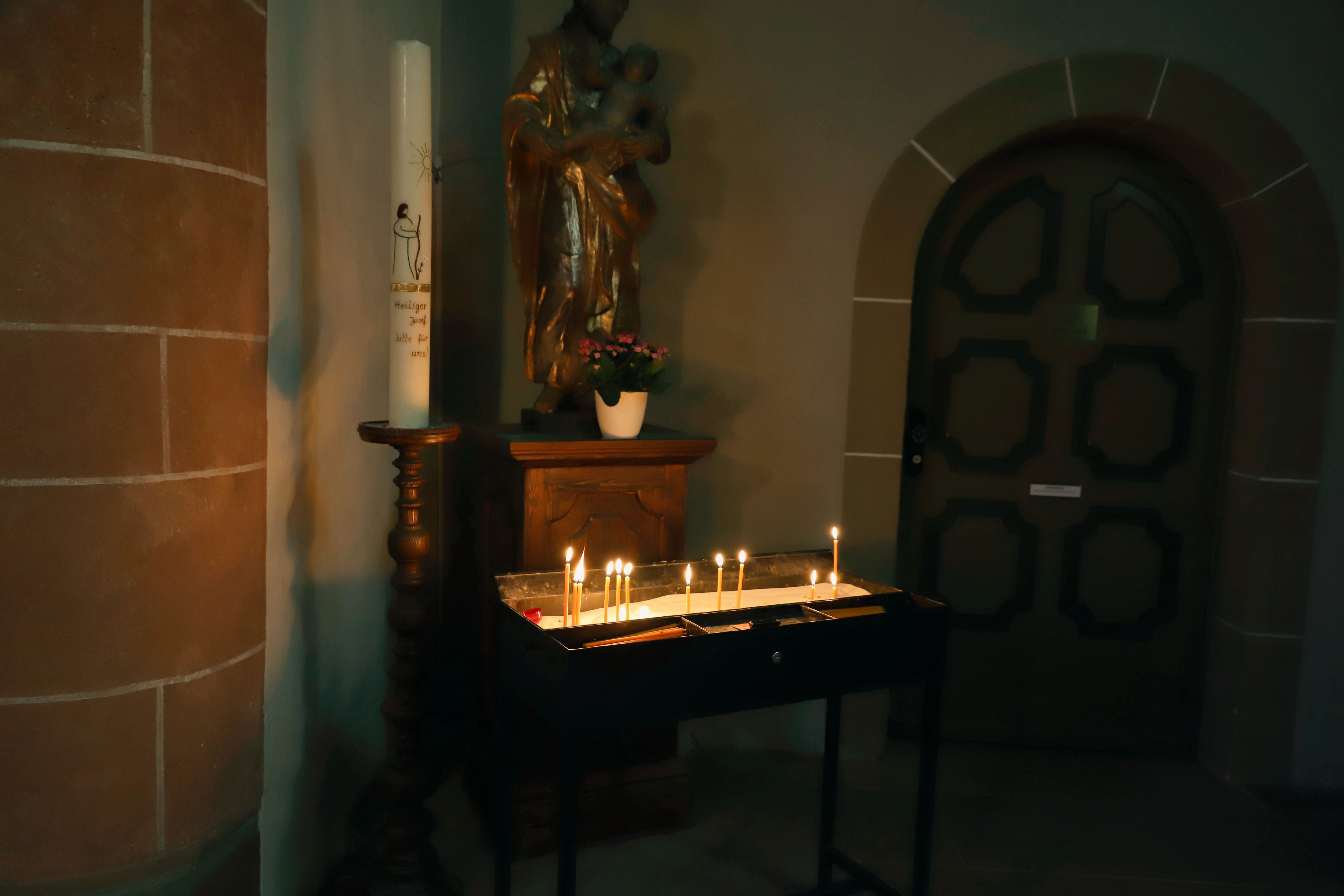 Candlelit Prayer Nook in Historic Church · Free Stock Photo