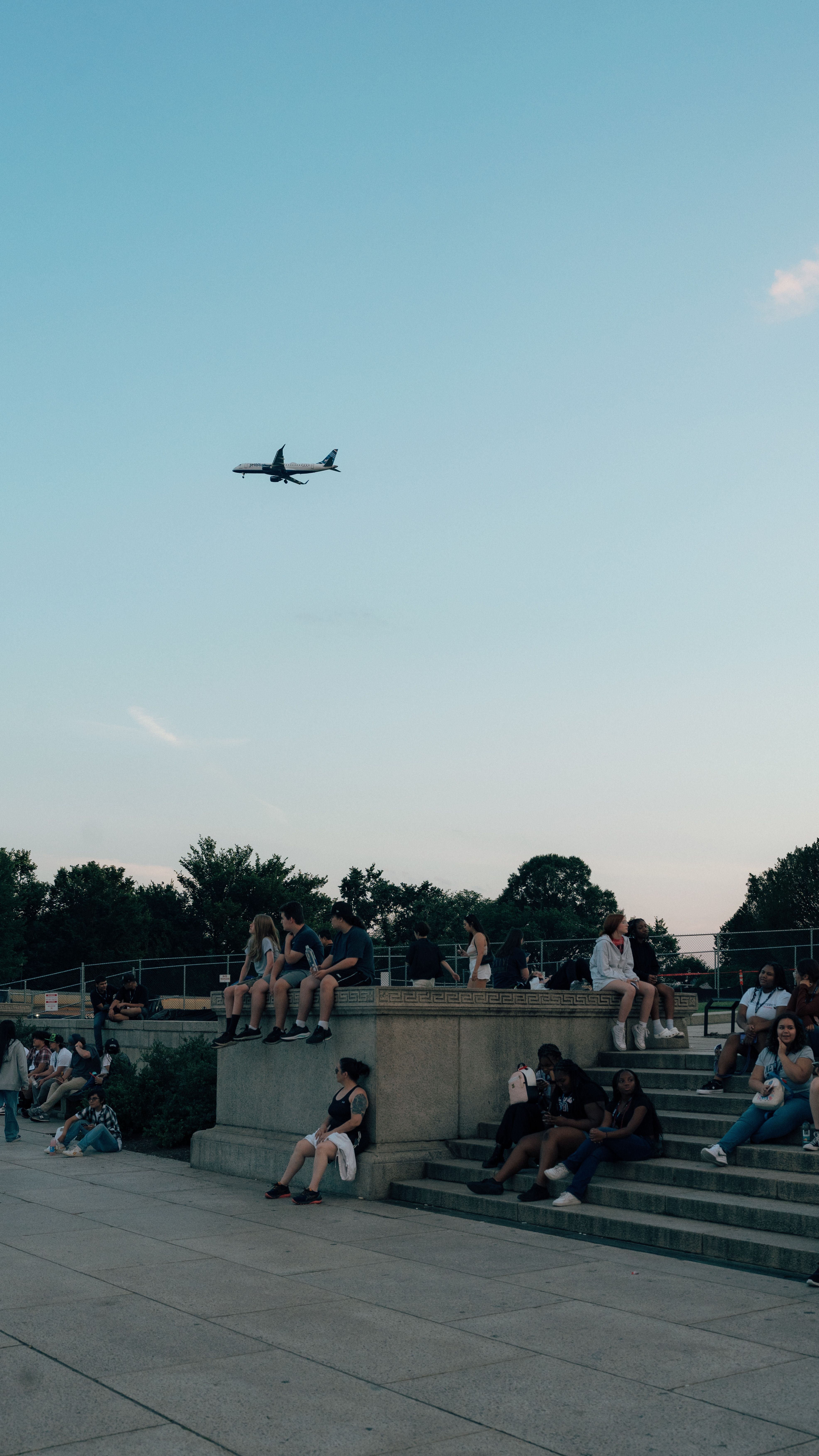 Crowd Relaxing in Urban Park with Airplane · Free Stock Photo