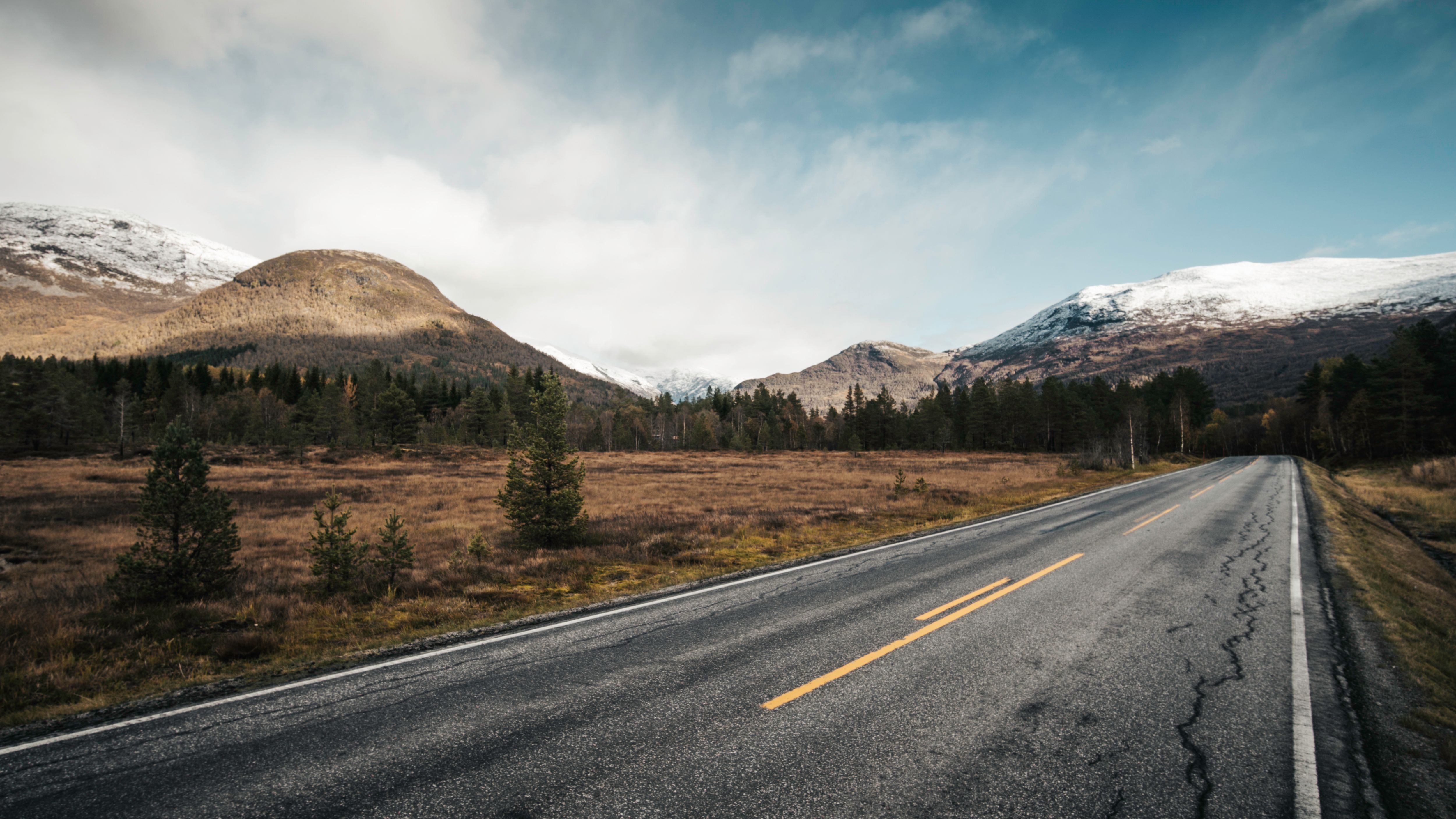 Scenic Mountain Road with Snow-Capped Peaks · Free Stock Photo