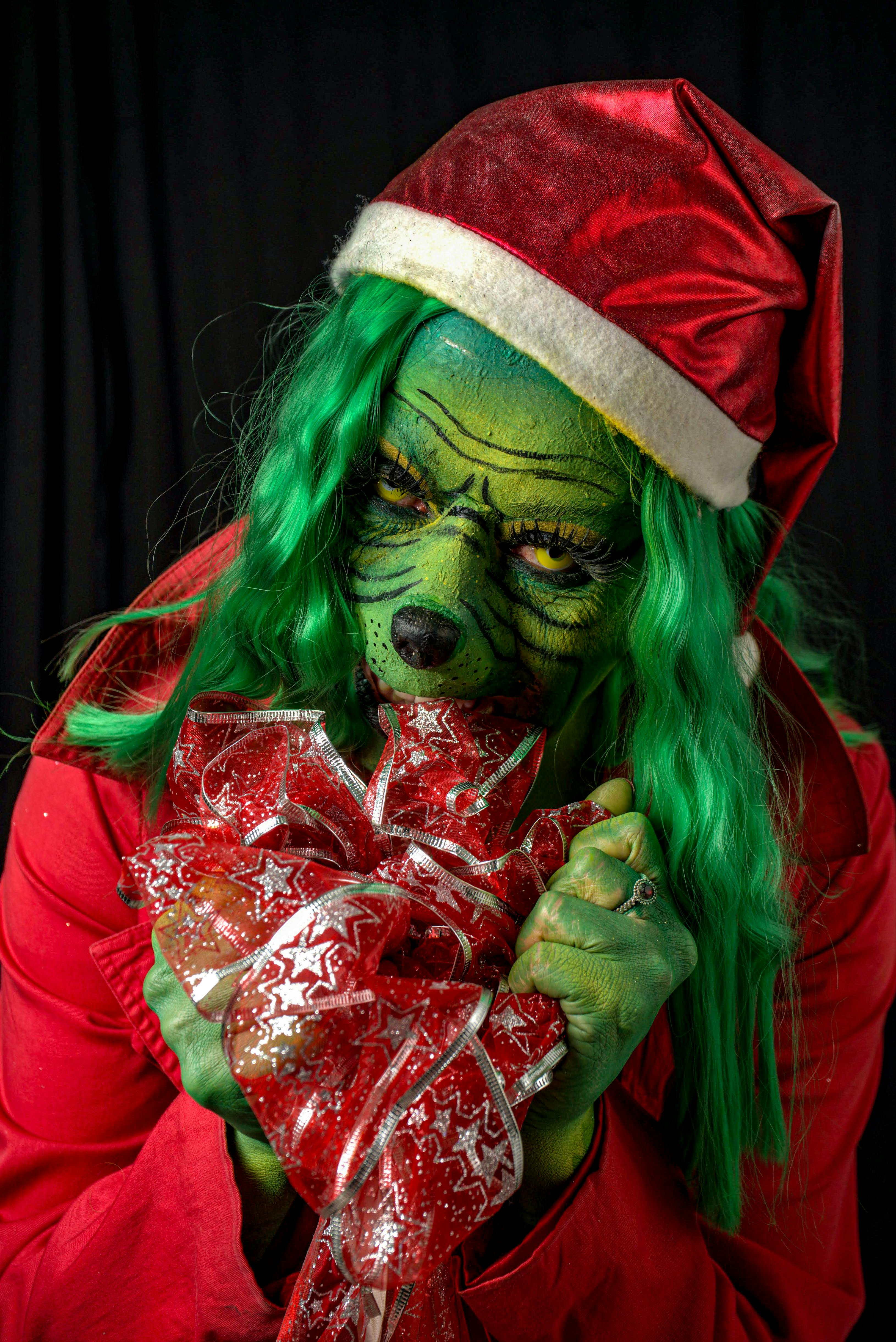 Festive Grinch Costume with Green Hair and Red Santa Hat · Free Stock Photo