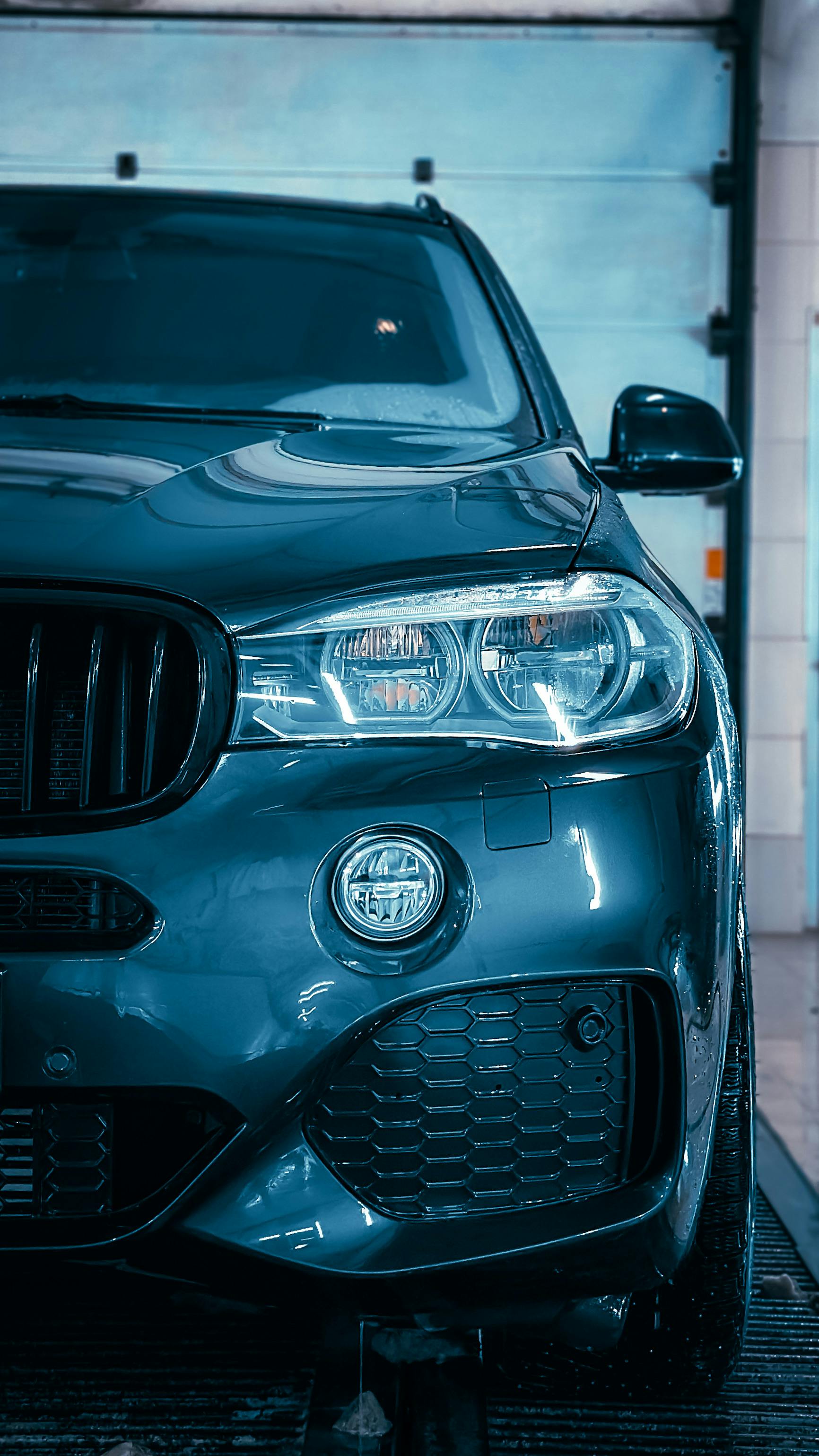 Close-Up of Luxury Car Front at Garage · Free Stock Photo