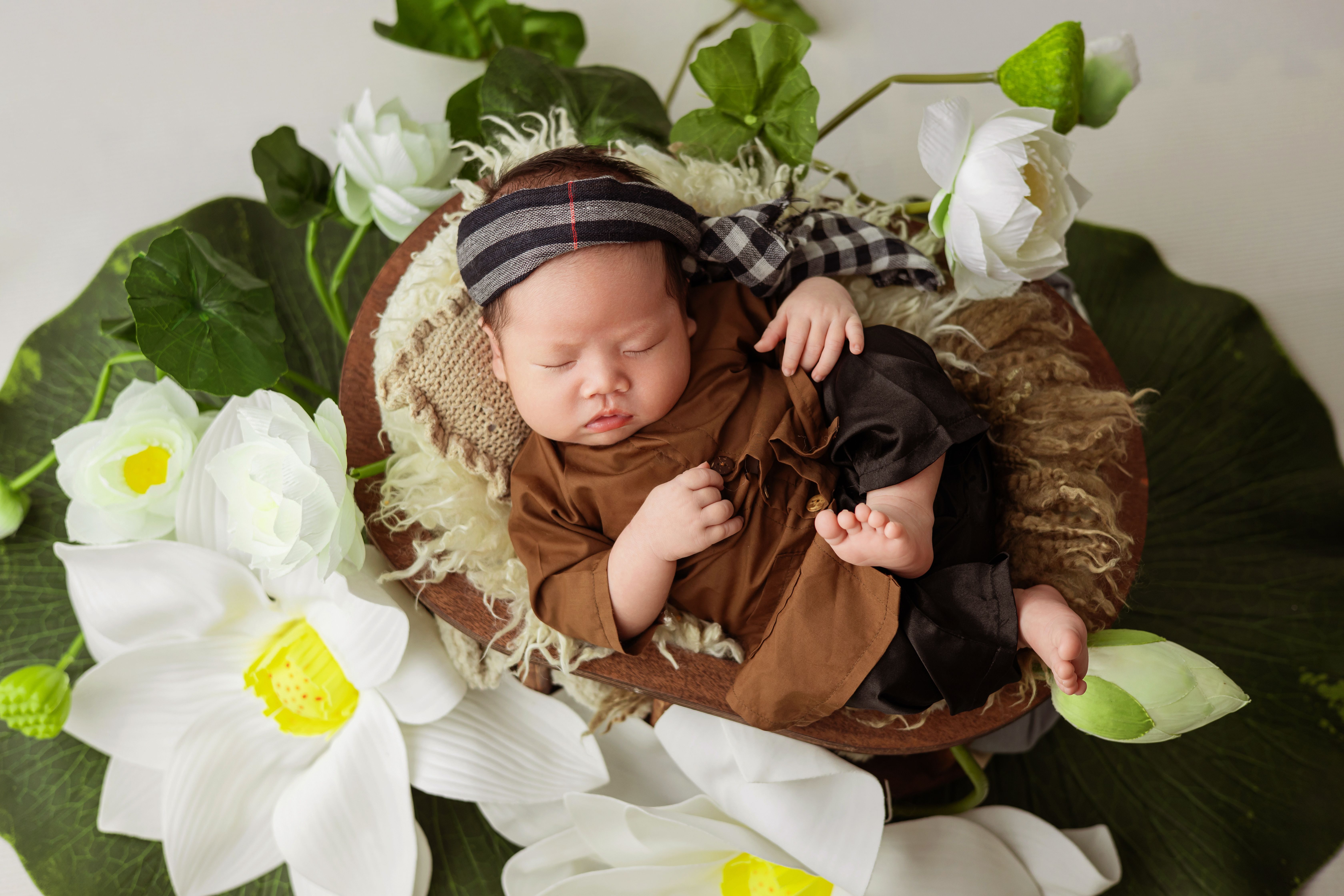 Peaceful Baby Sleeping Among Lotus Flowers · Free Stock Photo