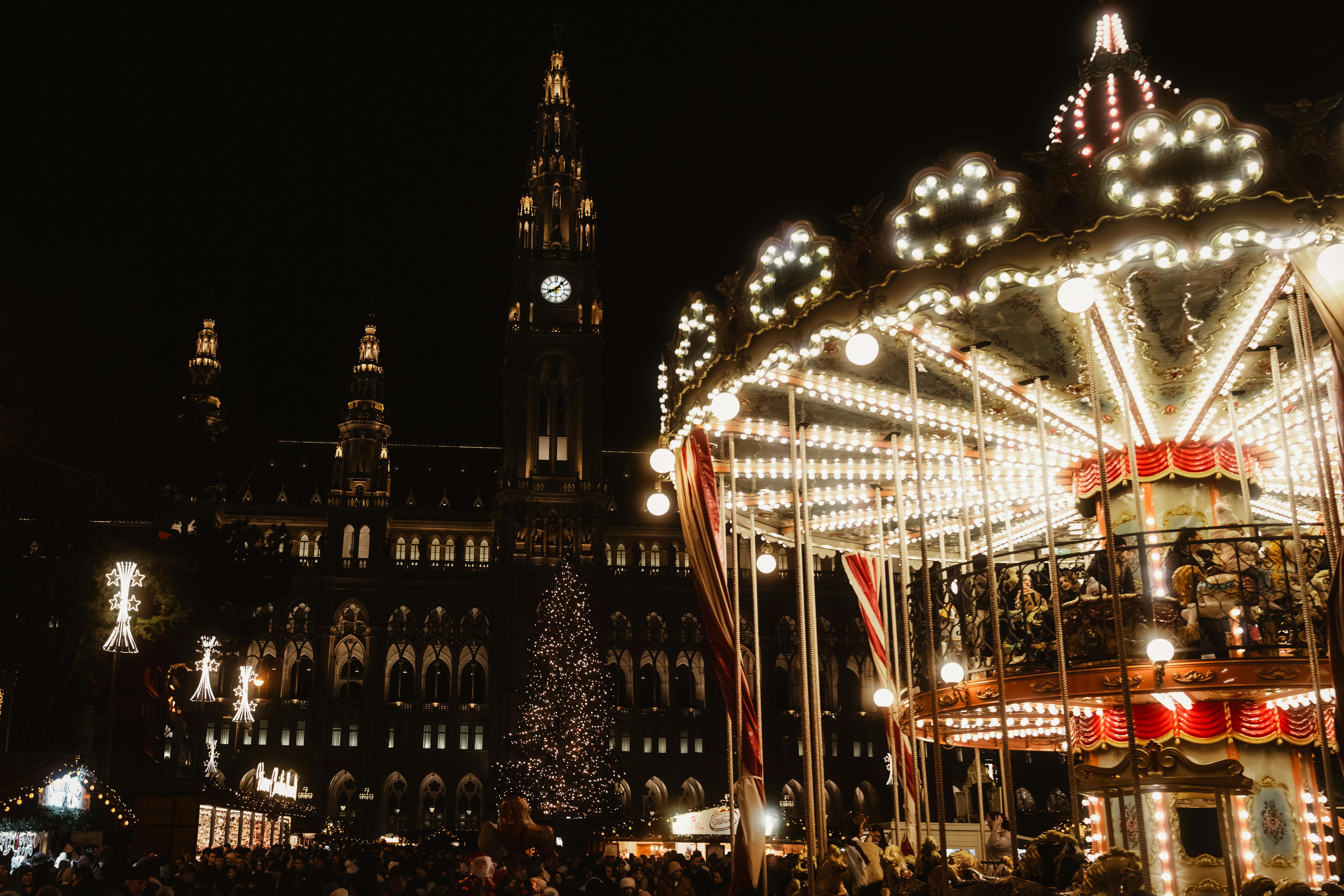 Vibrant Christmas Market with Carousel at Night · Free Stock Photo