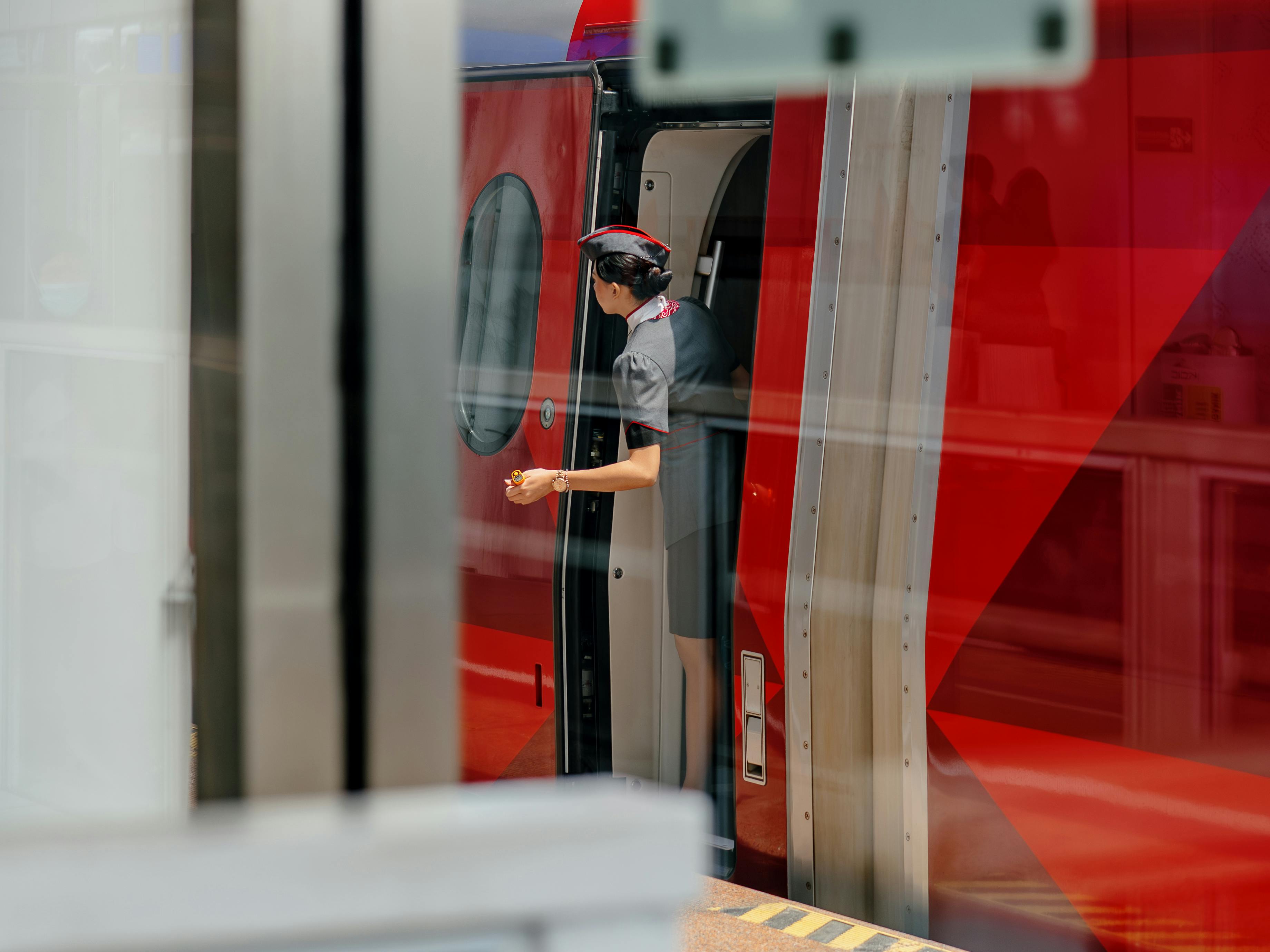 Train Conductor Boarding Metro in Jakarta · Free Stock Photo