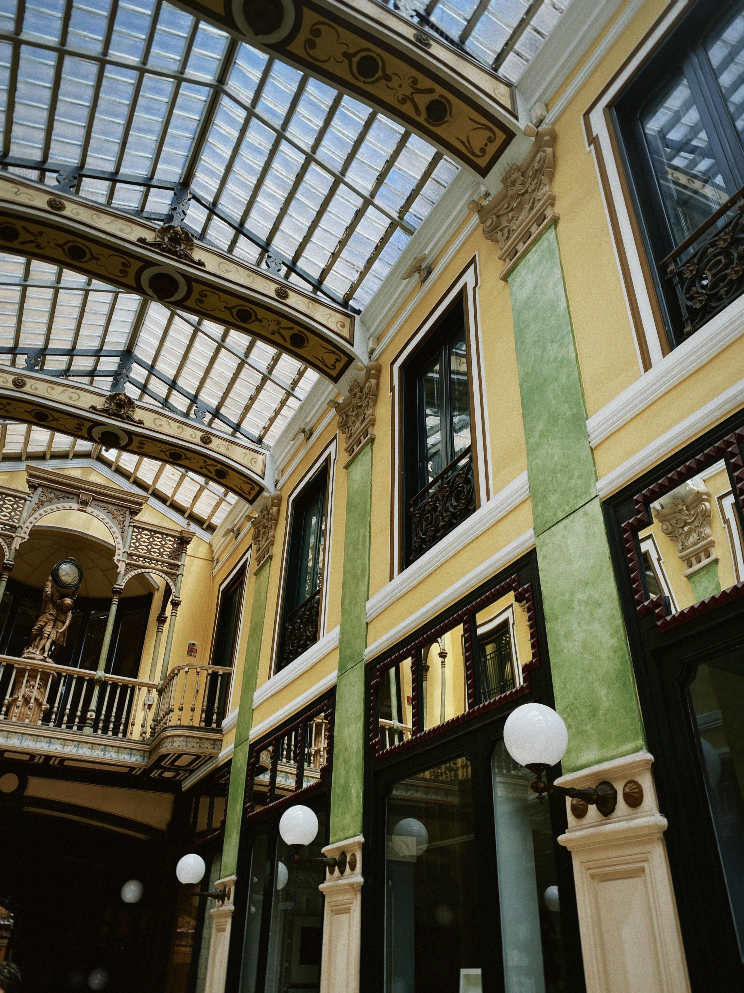 Elegant Indoor Architectural Atrium with Glass Roof · Free Stock Photo
