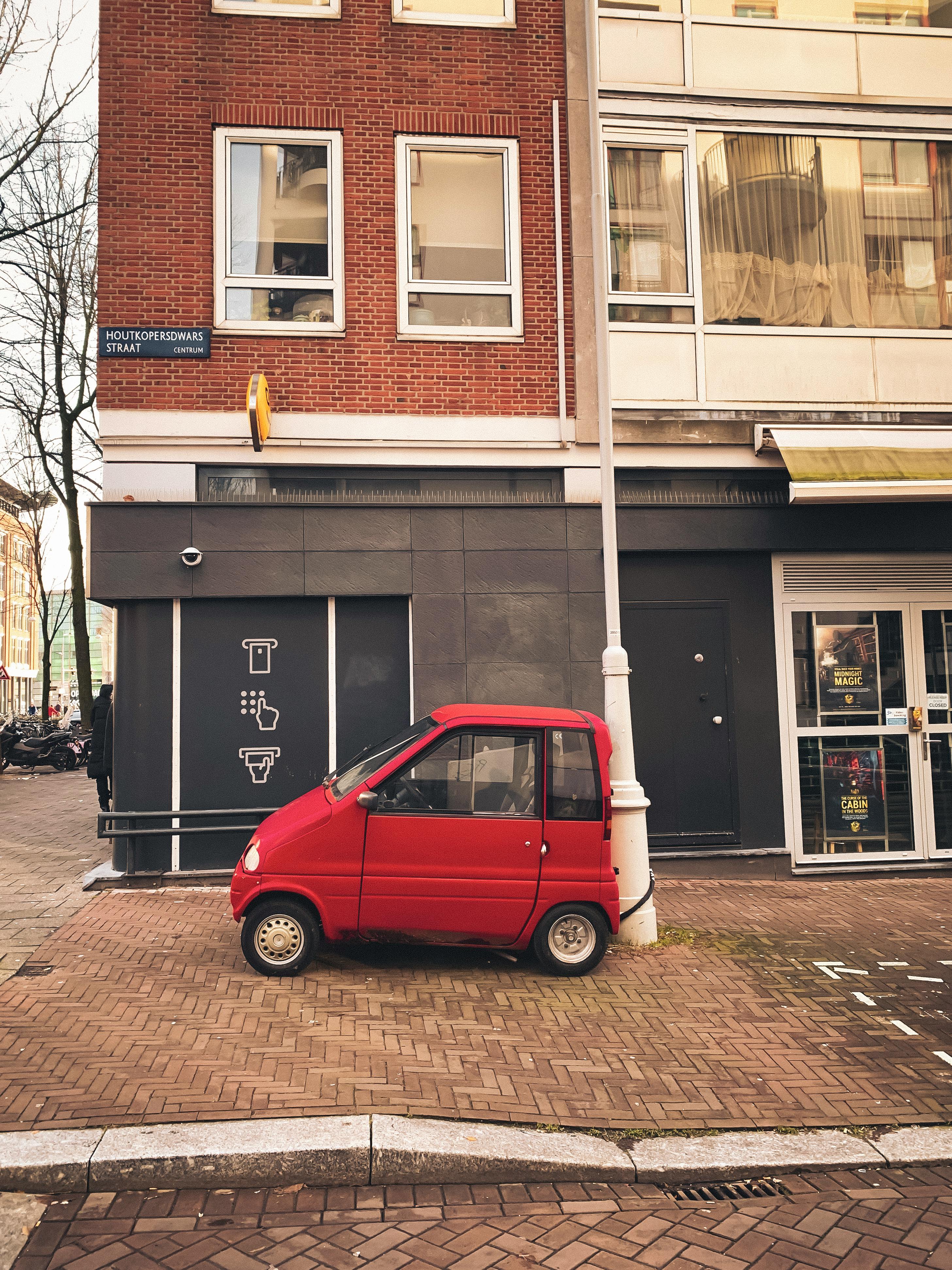 Vintage Red Microcar Parked in Amsterdam Street · Free Stock Photo