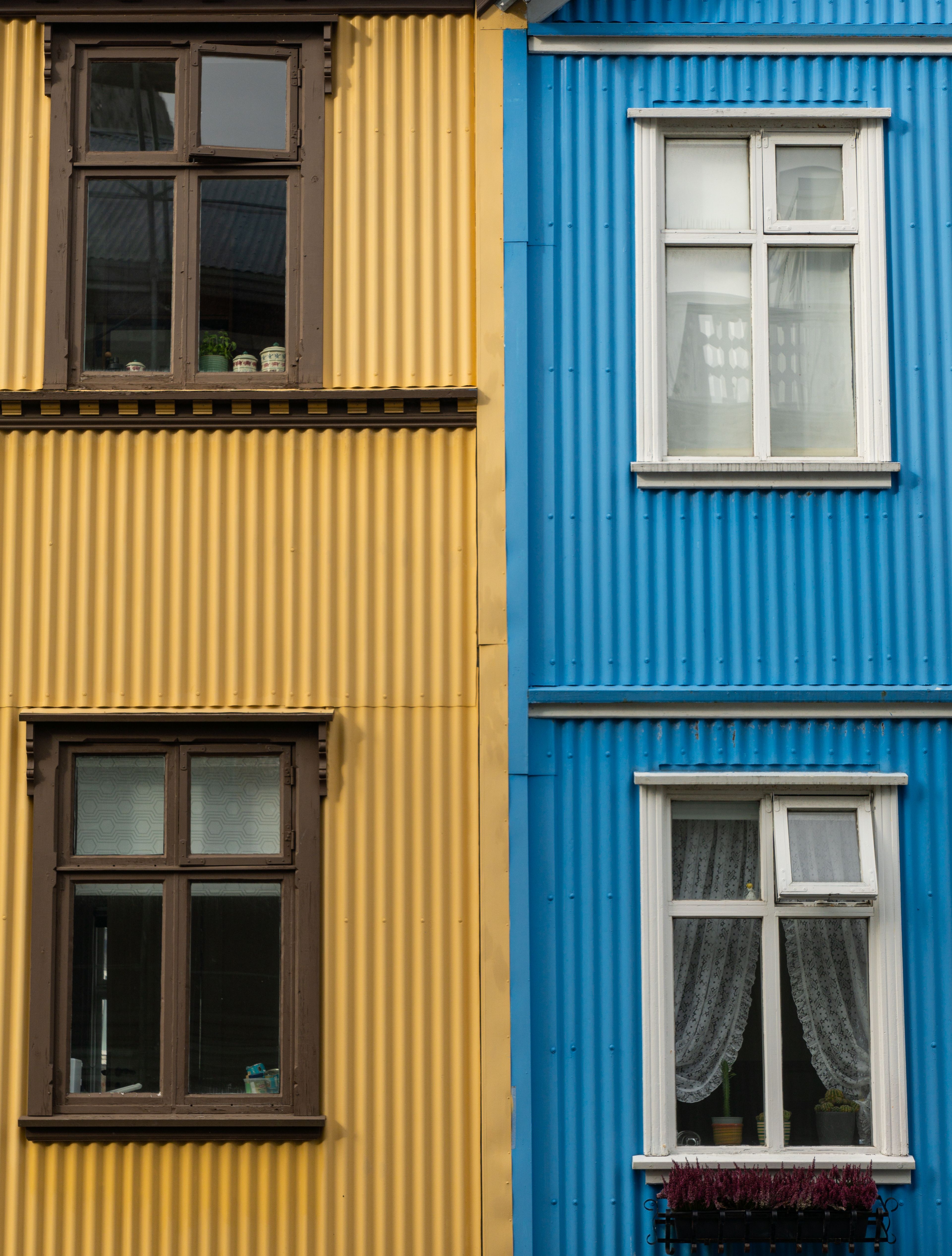 Vibrant Yellow and Blue Building Facade · Free Stock Photo