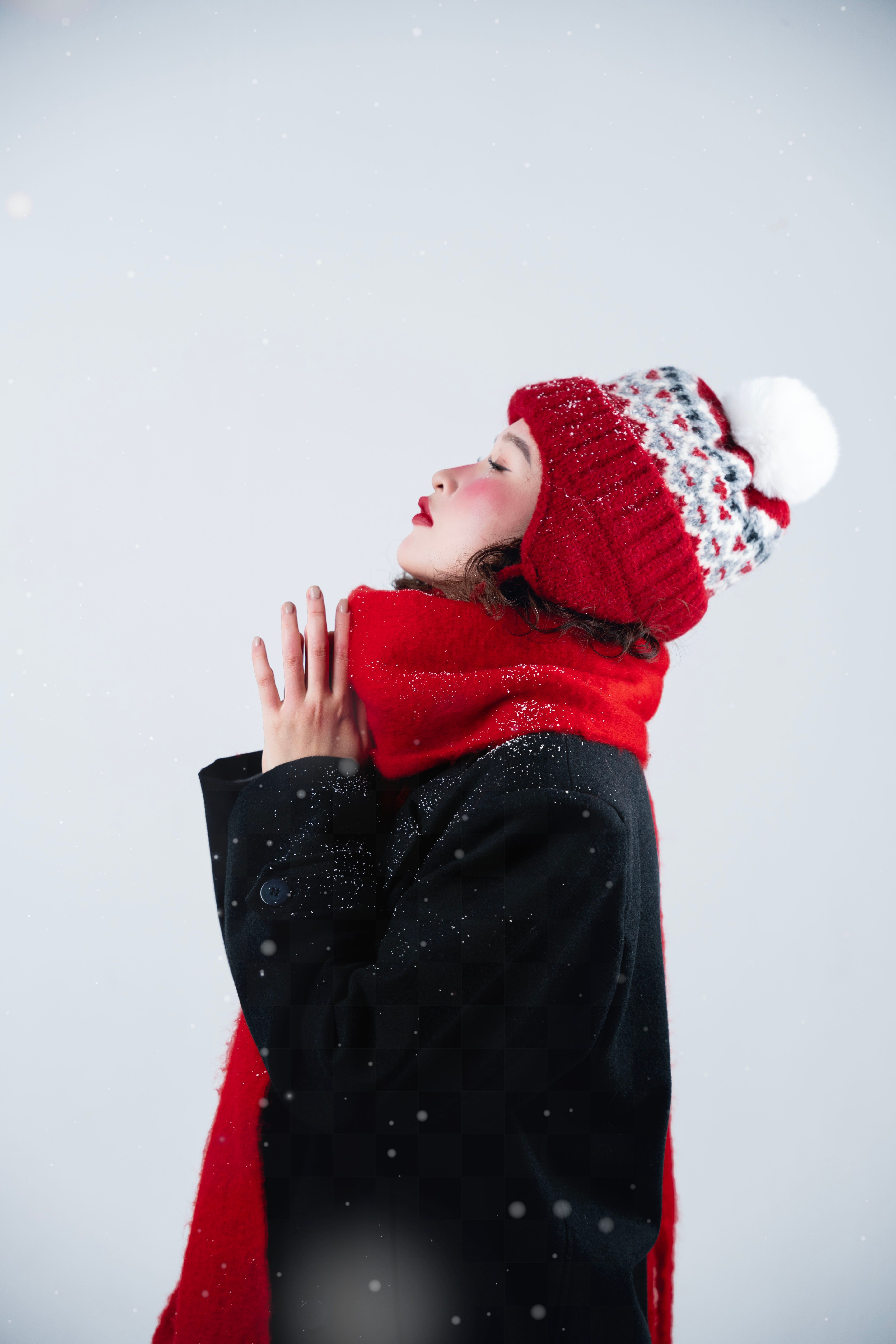 Woman in Red Winter Attire Praying in Snow · Free Stock Photo