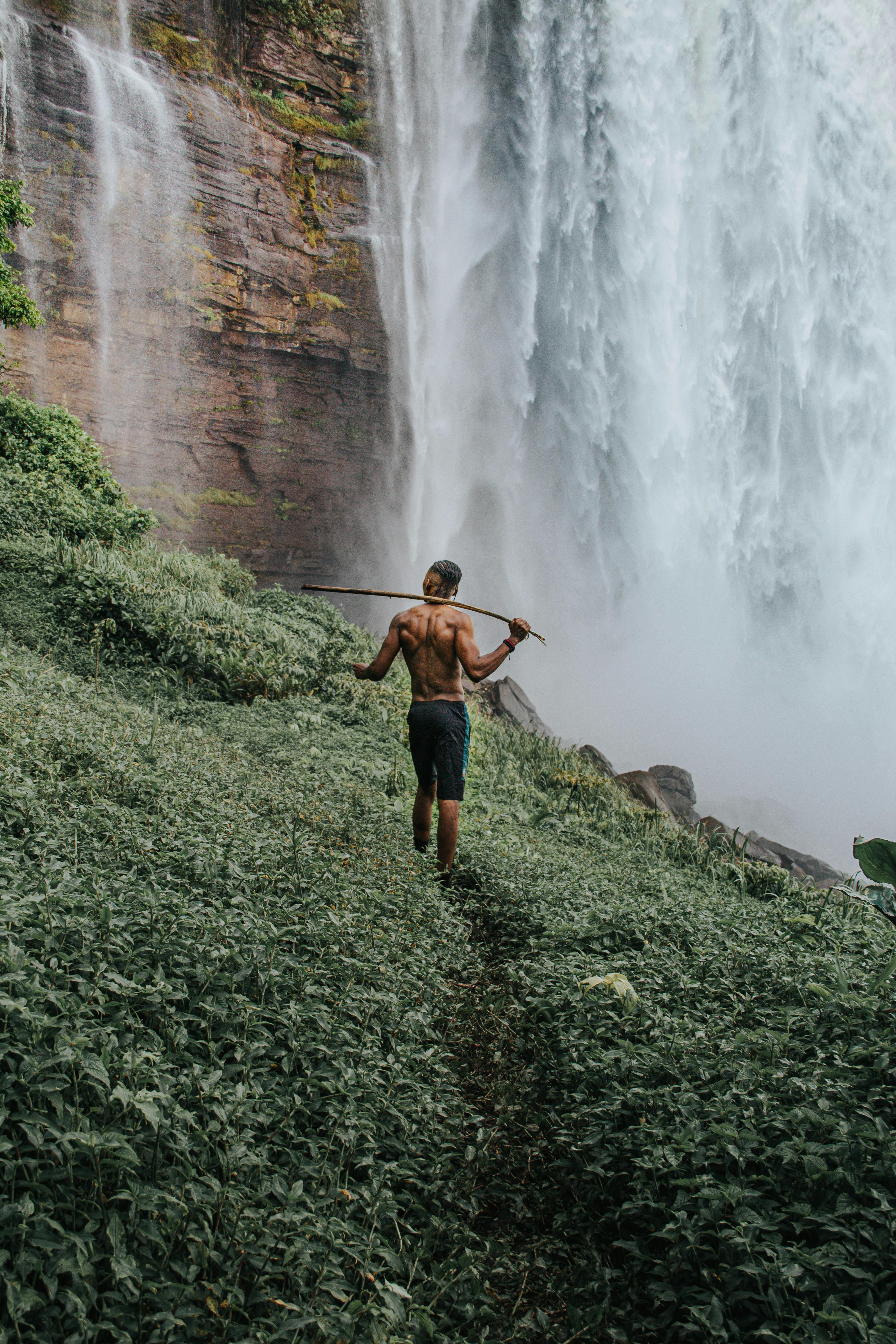 Man Standing by Majestic Kalandula Falls, Angola · Free Stock Photo