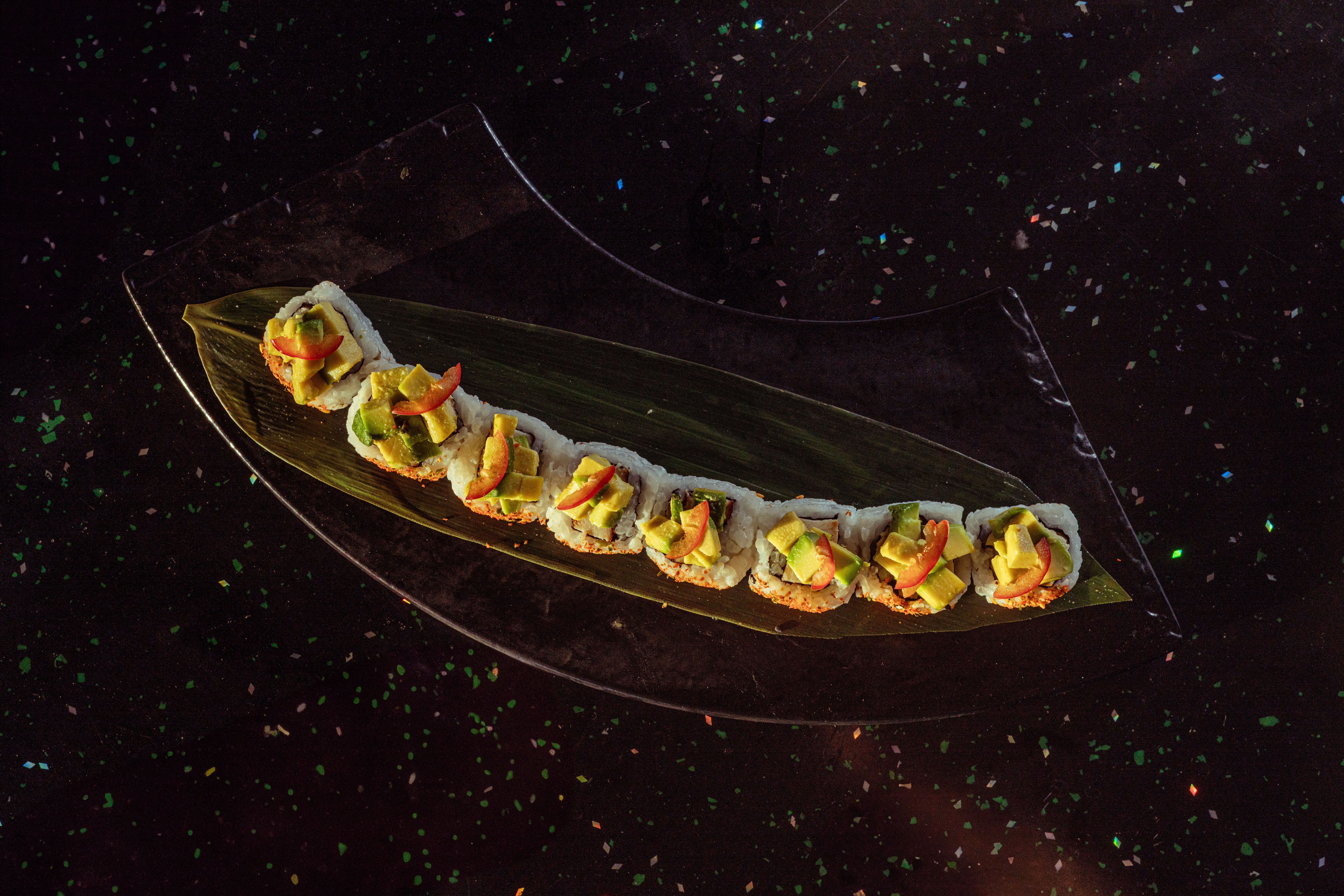Sushi Roll with Avocado and Peppers on Leaf Plate · Free Stock Photo