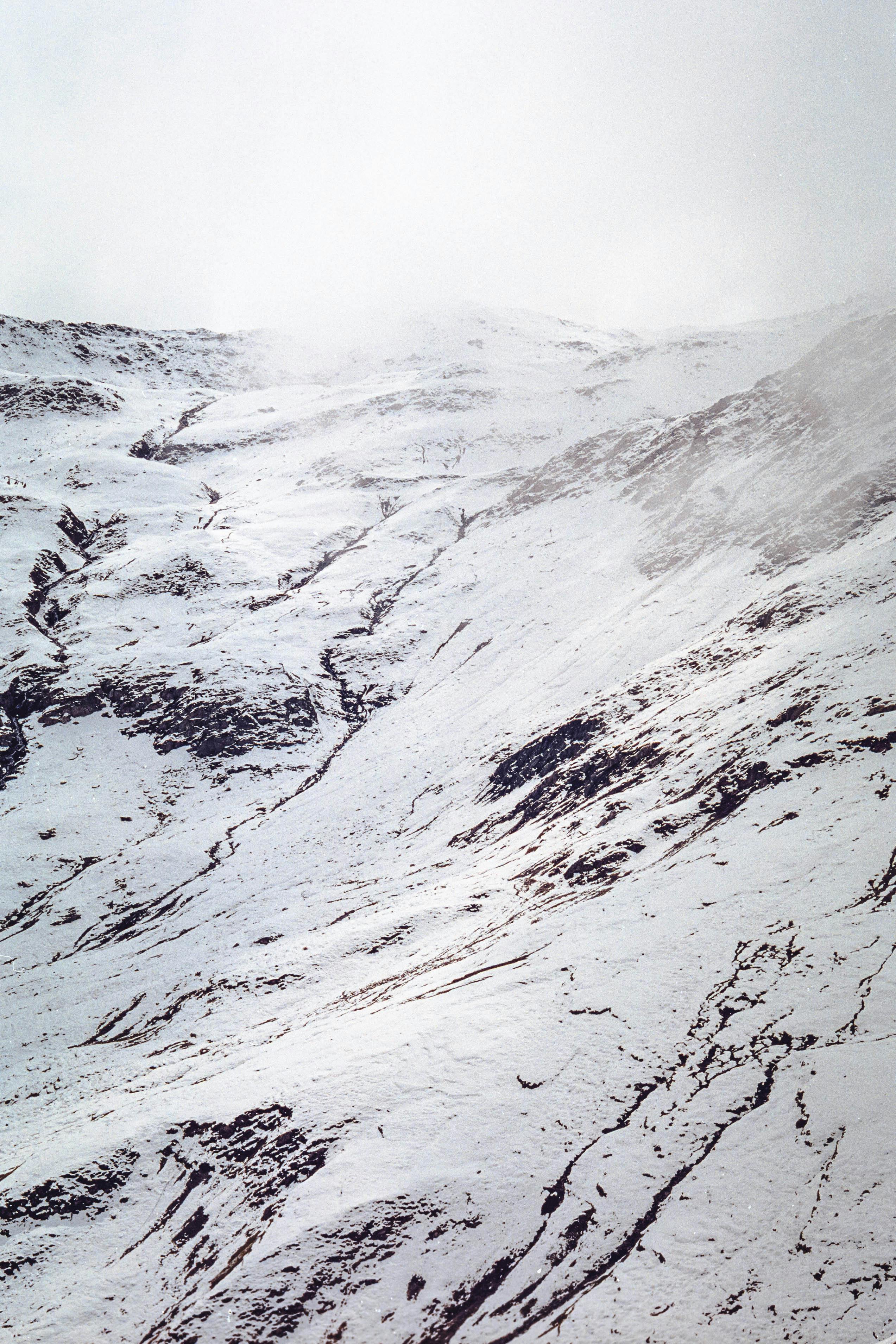 Snow-Covered Mountainside with Dramatic Texture · Free Stock Photo