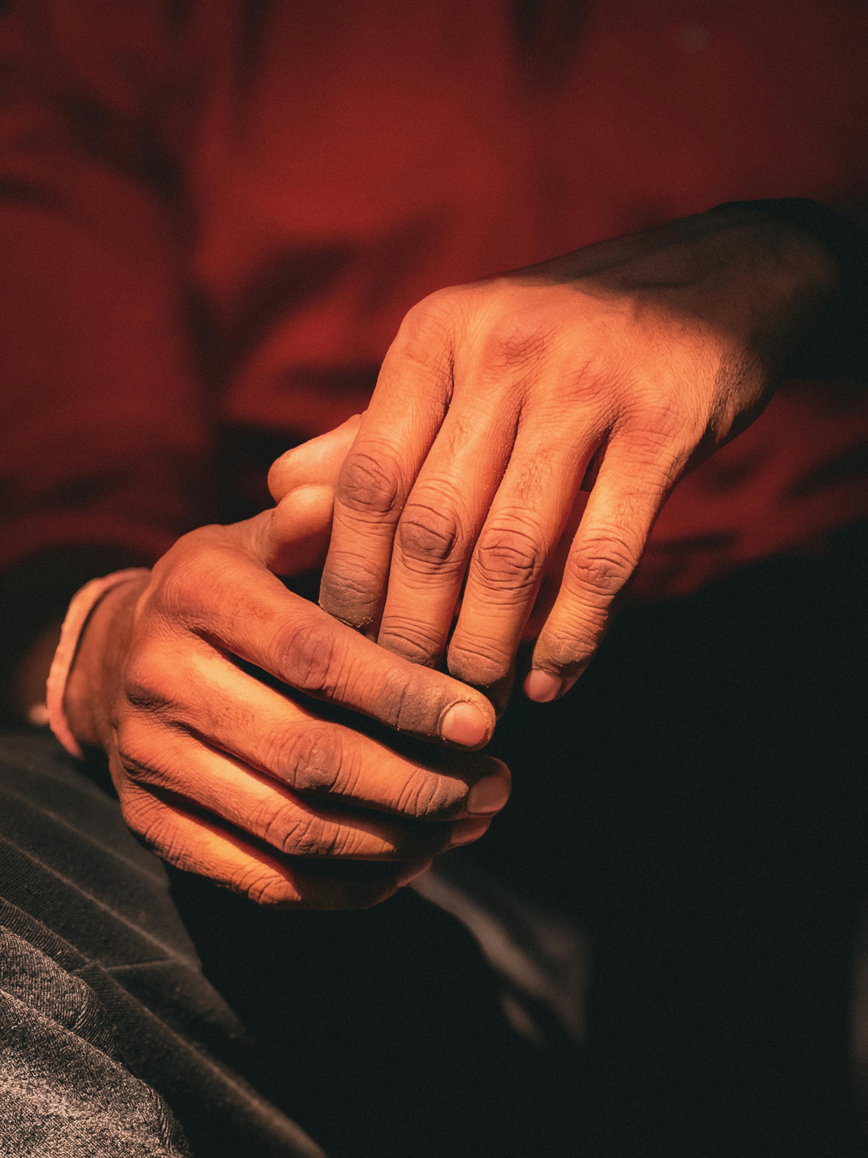 Close-Up of Hands in Warm Lighting · Free Stock Photo