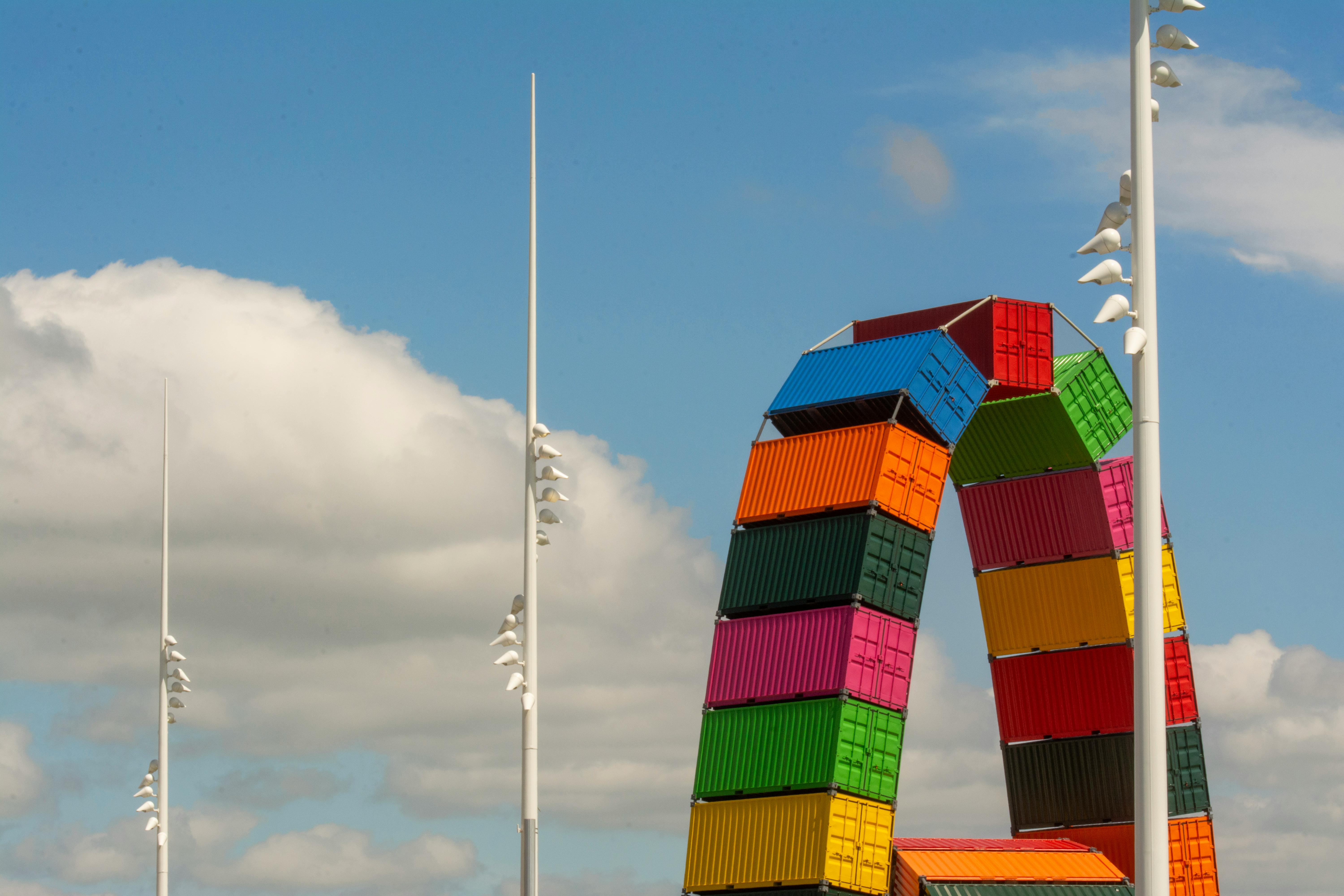 Colorful Shipping Container Arch Under Blue Sky · Free Stock Photo