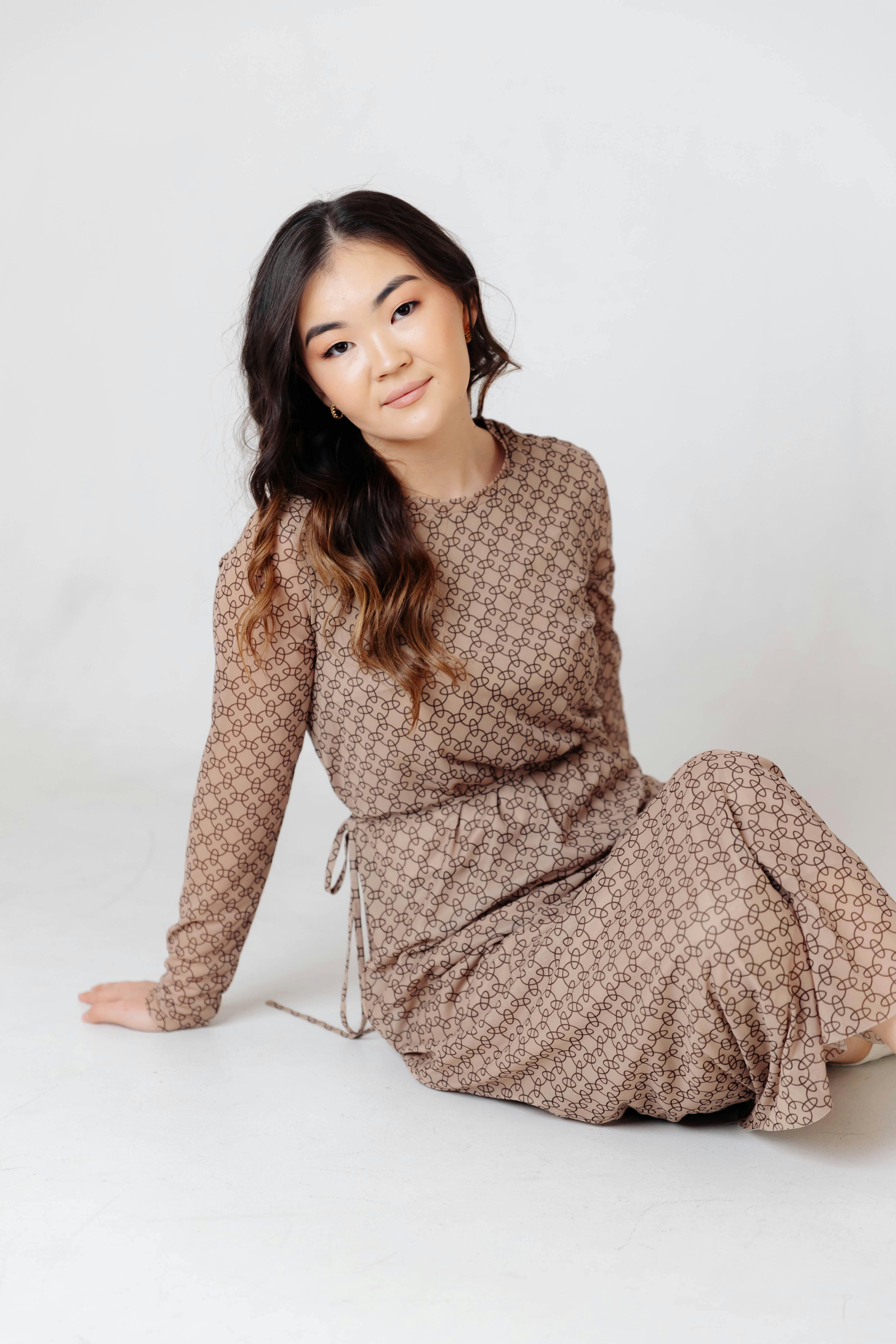 Elegant Portrait of Woman in Brown Patterned Dress · Free Stock Photo