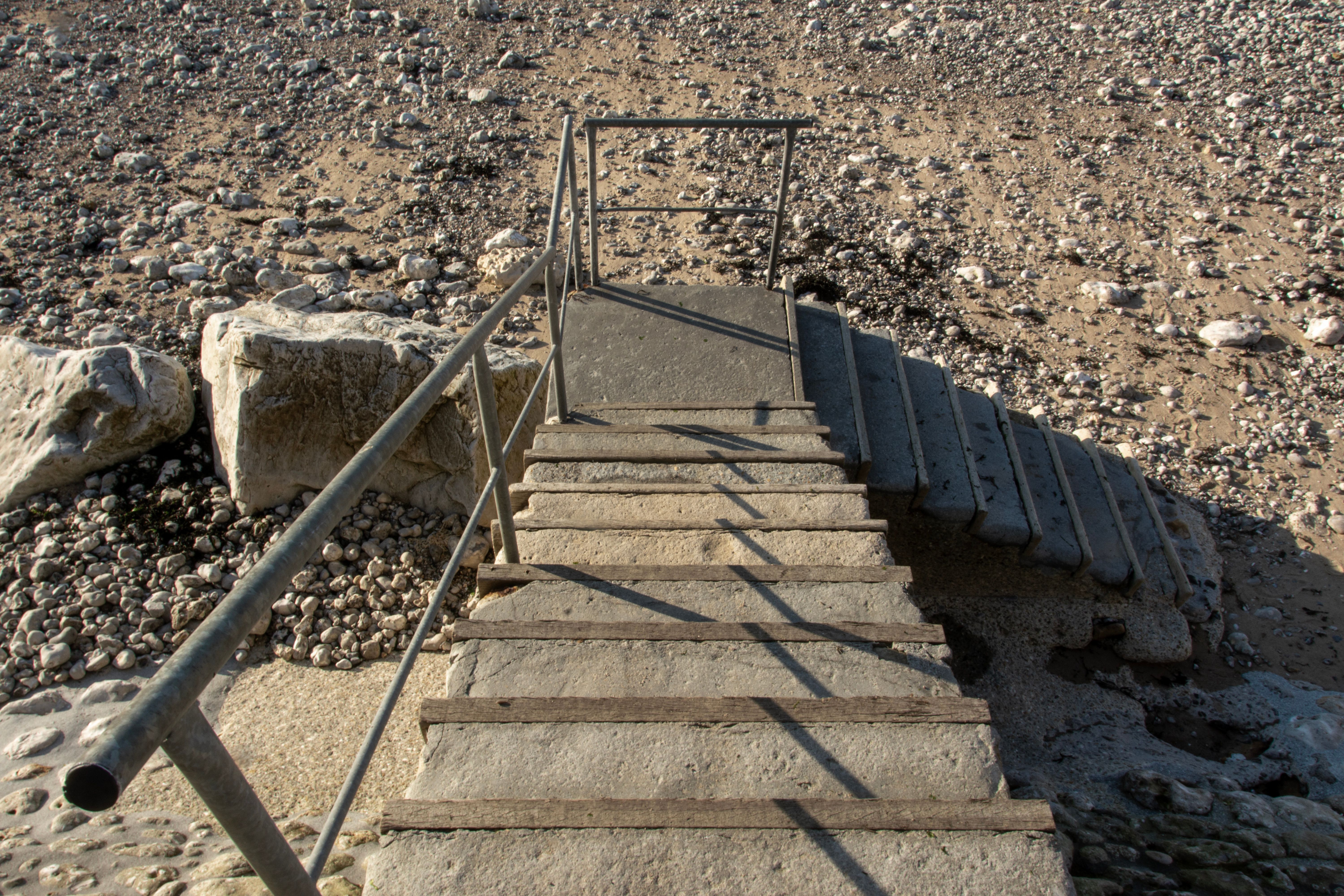 Concrete Stairs Leading to Rocky Beach Shore · Free Stock Photo