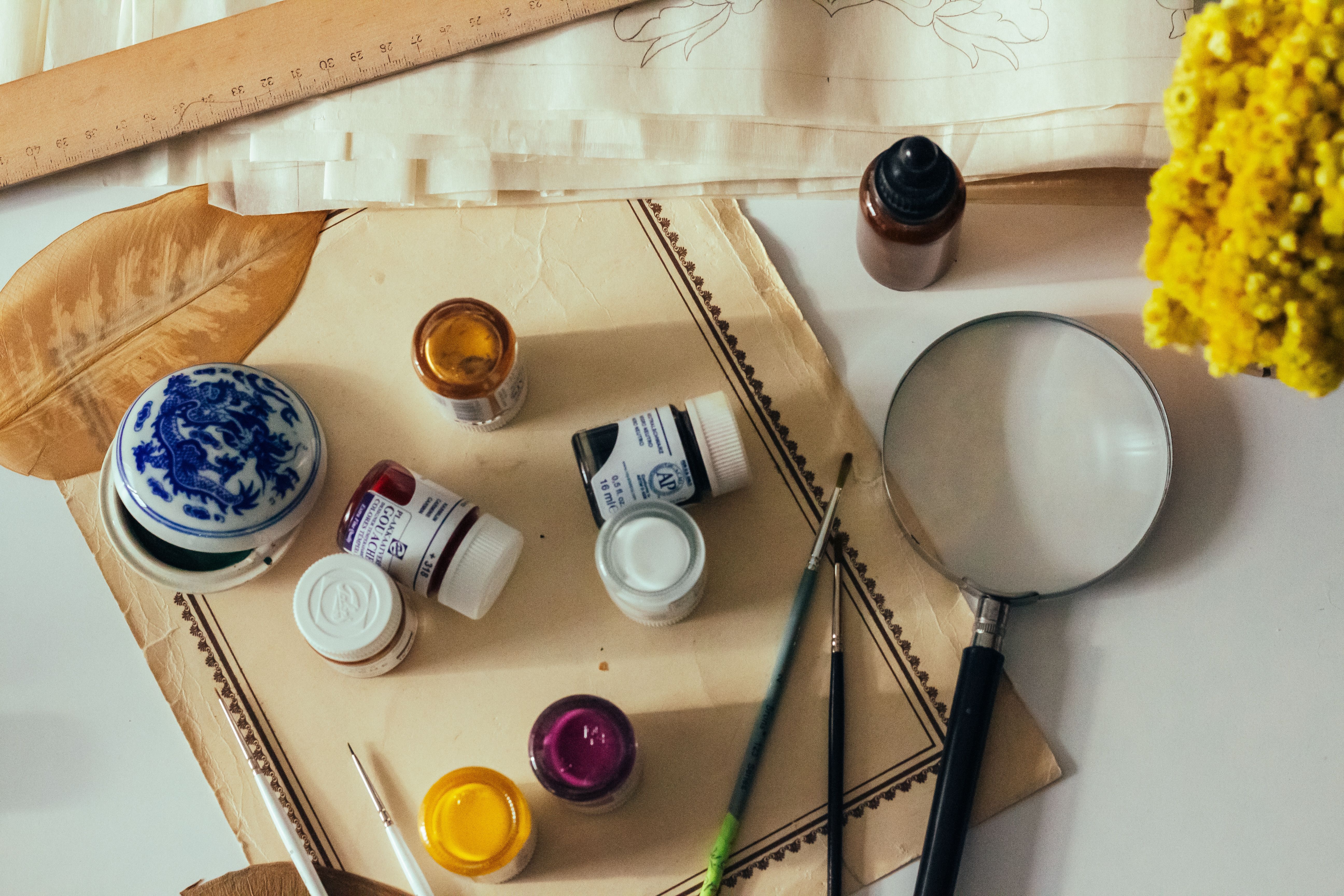 Art Supplies Flat Lay with Magnifying Glass · Free Stock Photo