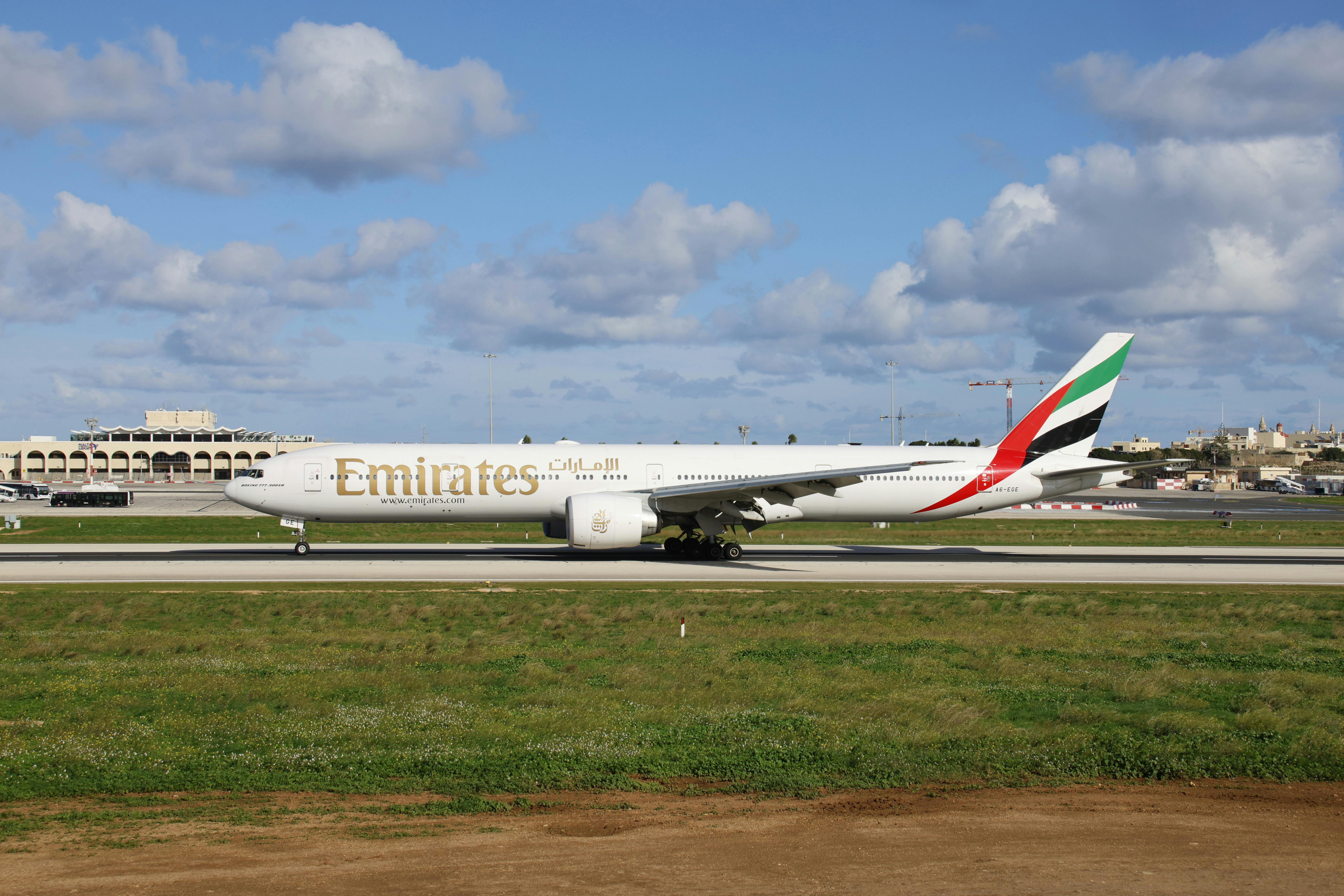 Emirates Airplane on Runway at Airport · Free Stock Photo