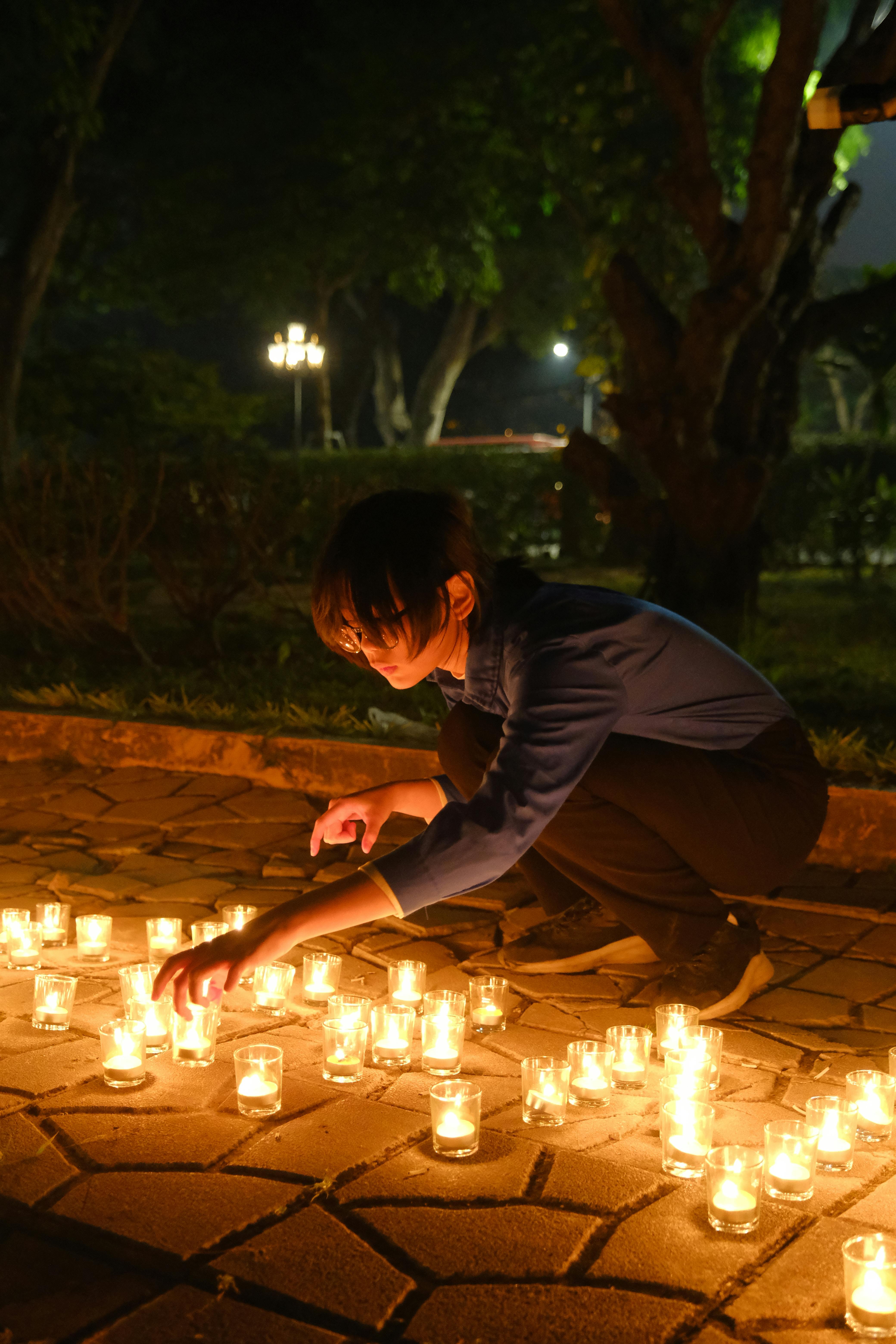 Candlelight Vigil at Night in a Park Setting · Free Stock Photo