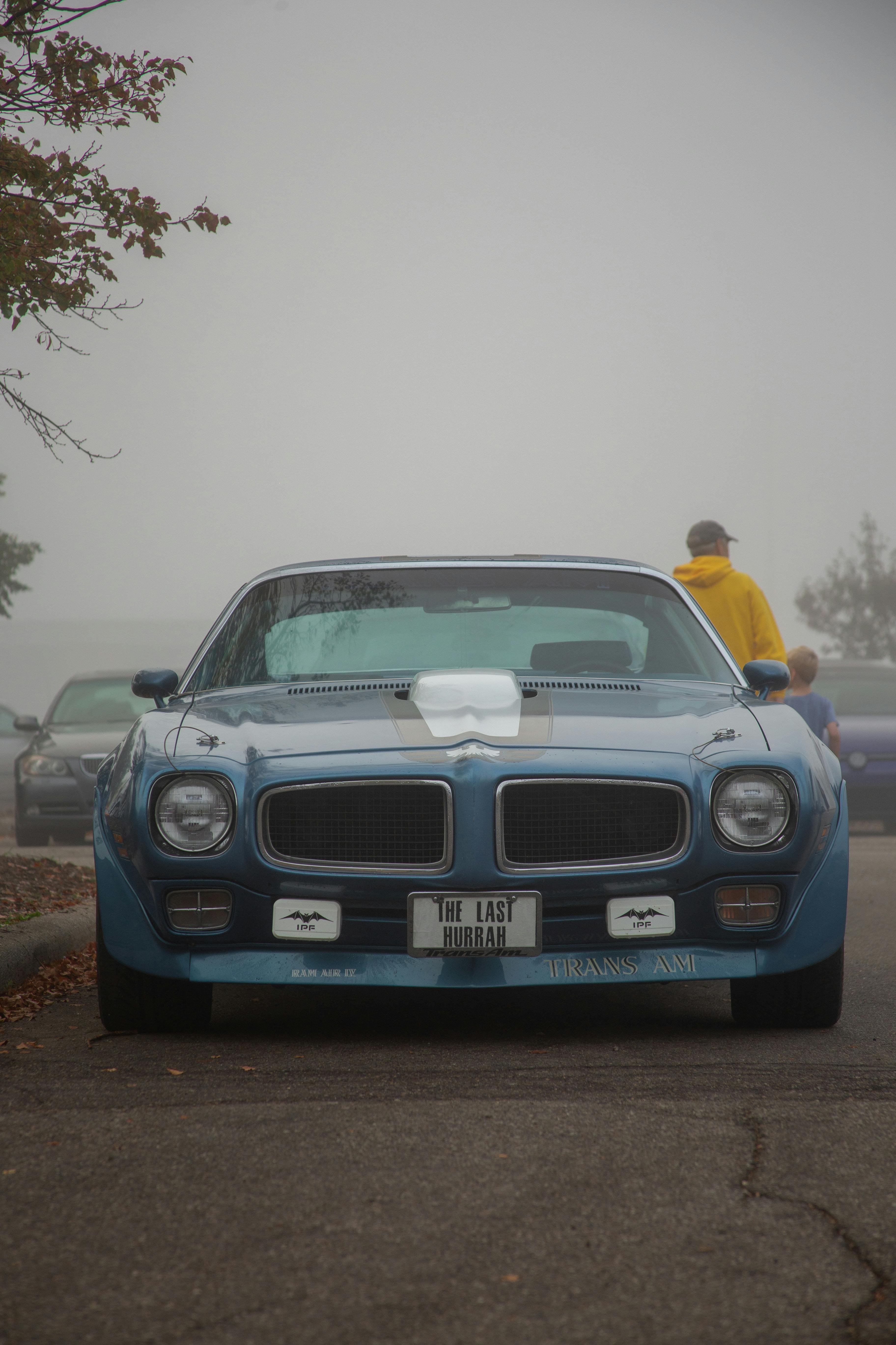 Classic Blue Pontiac Trans Am on Foggy Street · Free Stock Photo