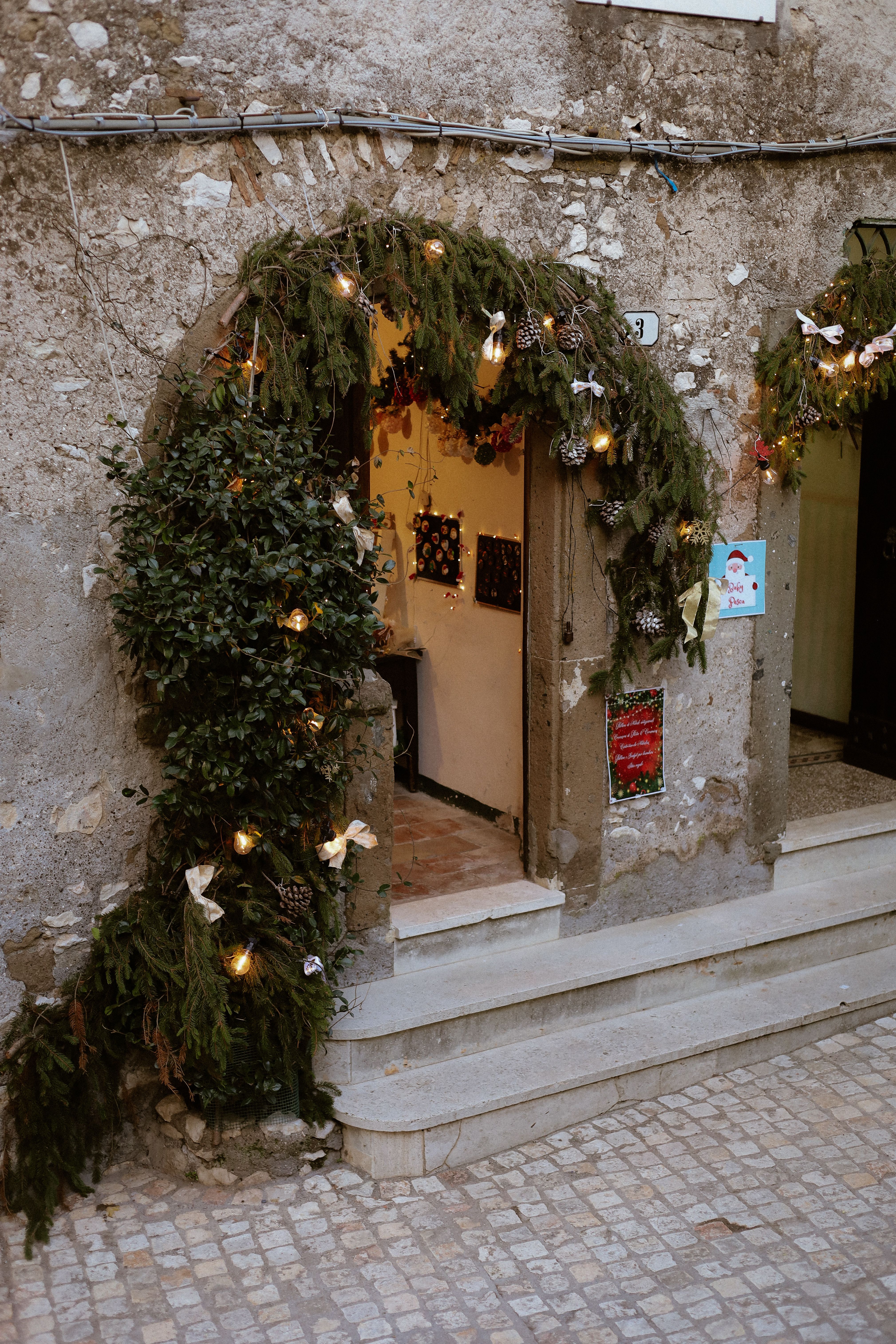 Charming Decorated Rustic Doorway in a Stone Alley · Free Stock Photo