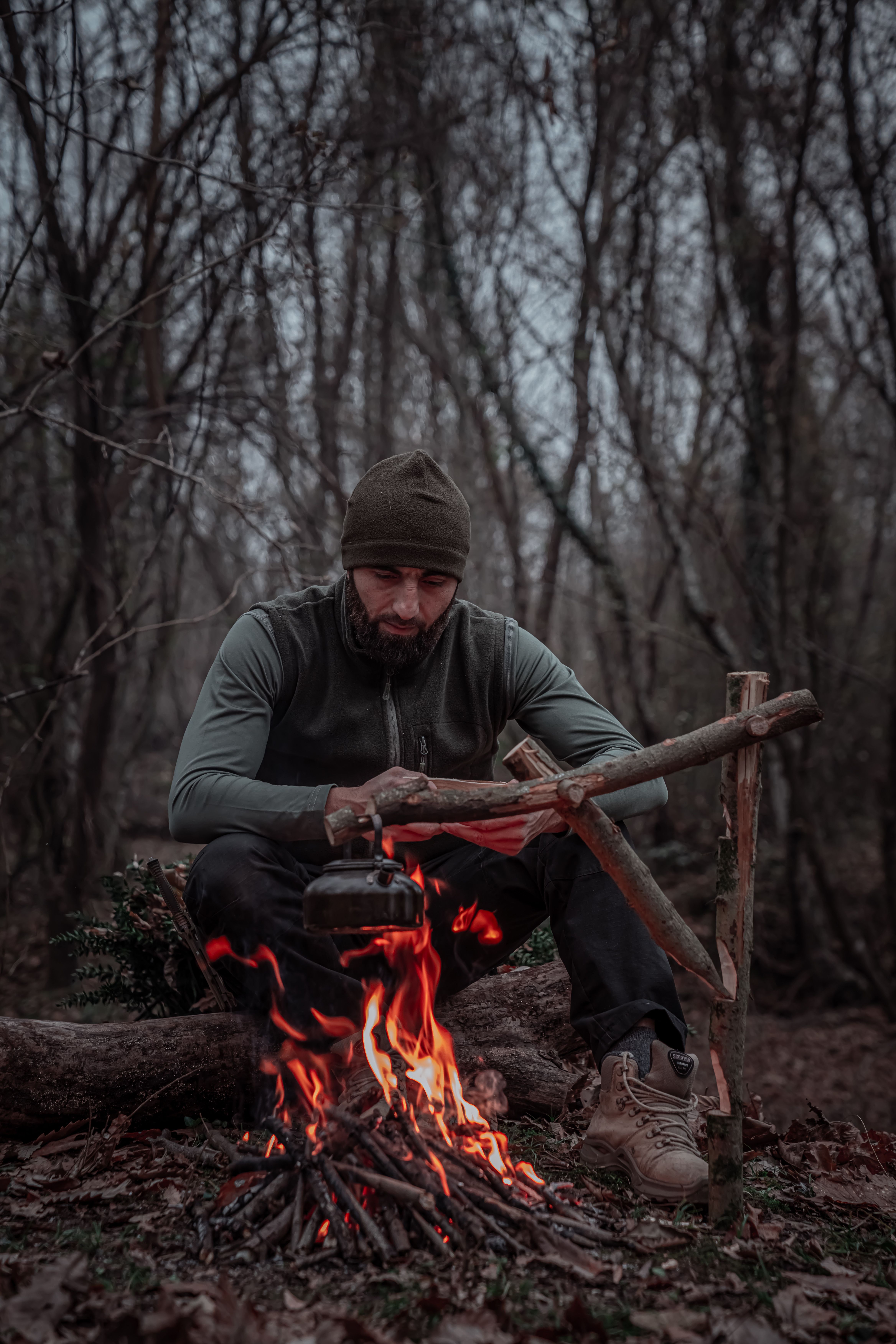 Man Camping in Forest with Campfire Cooking Scene · Free Stock Photo